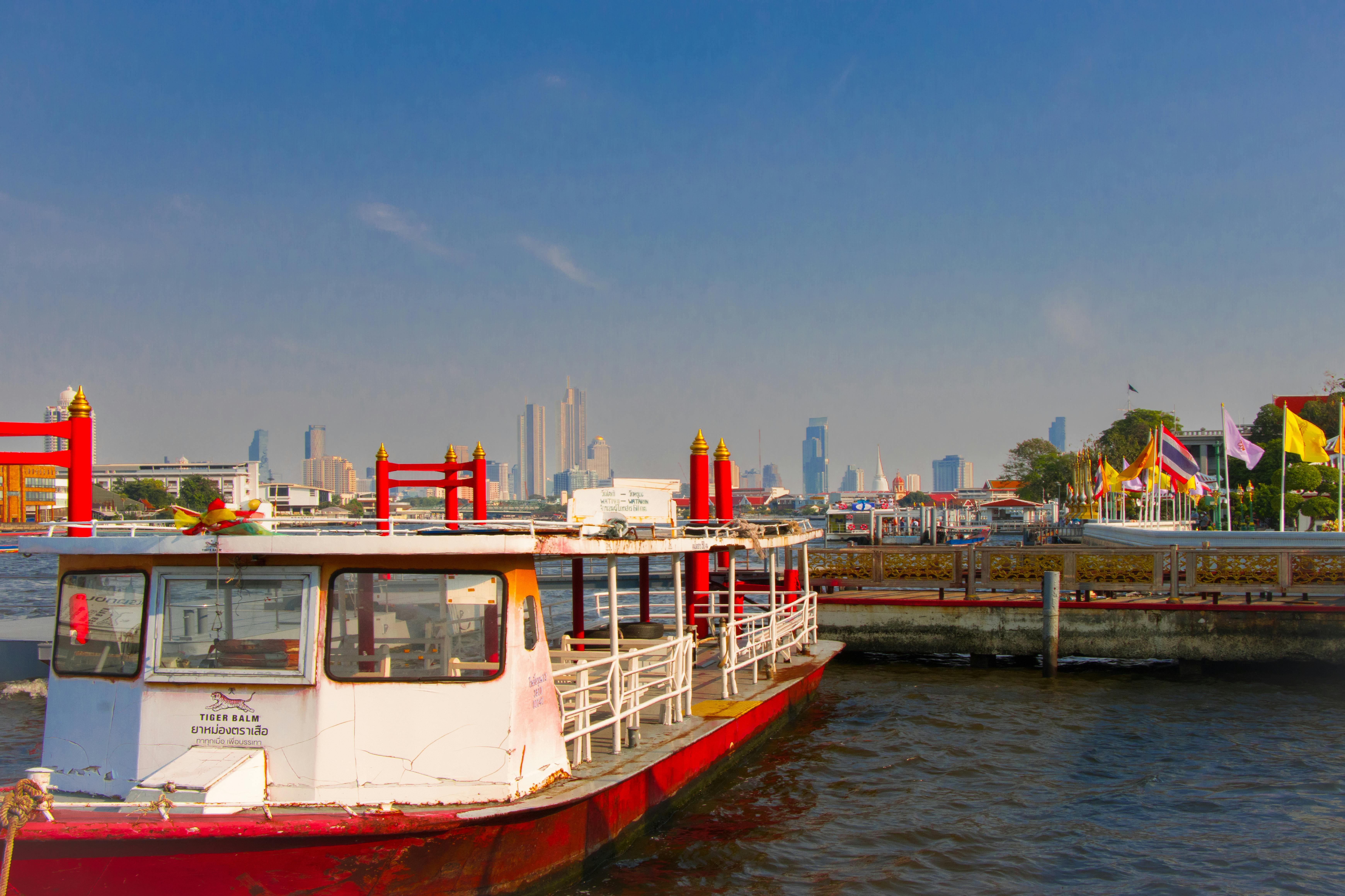 A White and Red Ferry Docked Near a Pier · Free Stock Photo
