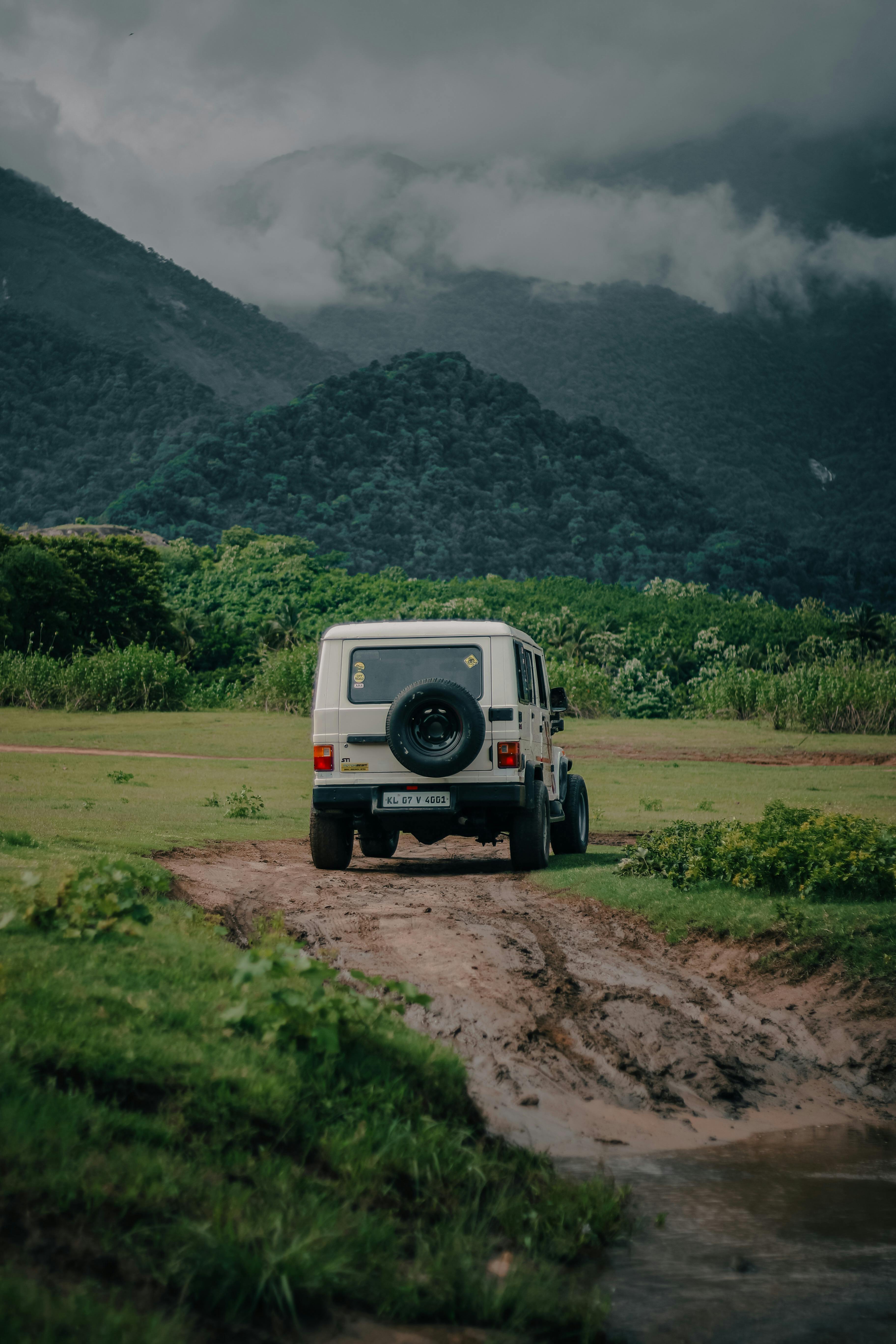 White Vehicle Driving on Dirt Road · Free Stock Photo