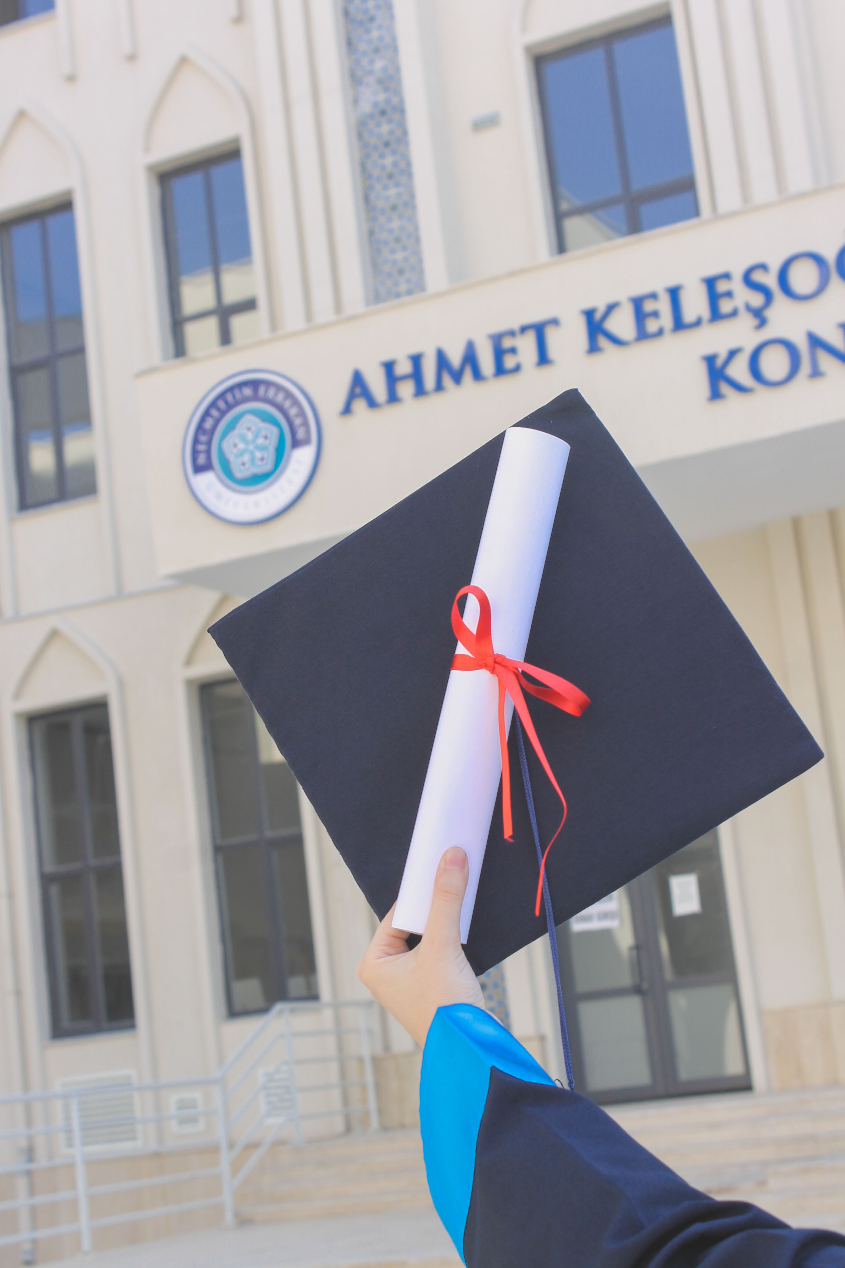 Close-Up Shot of a Person Holding Square Academic Cap and Diploma ...
