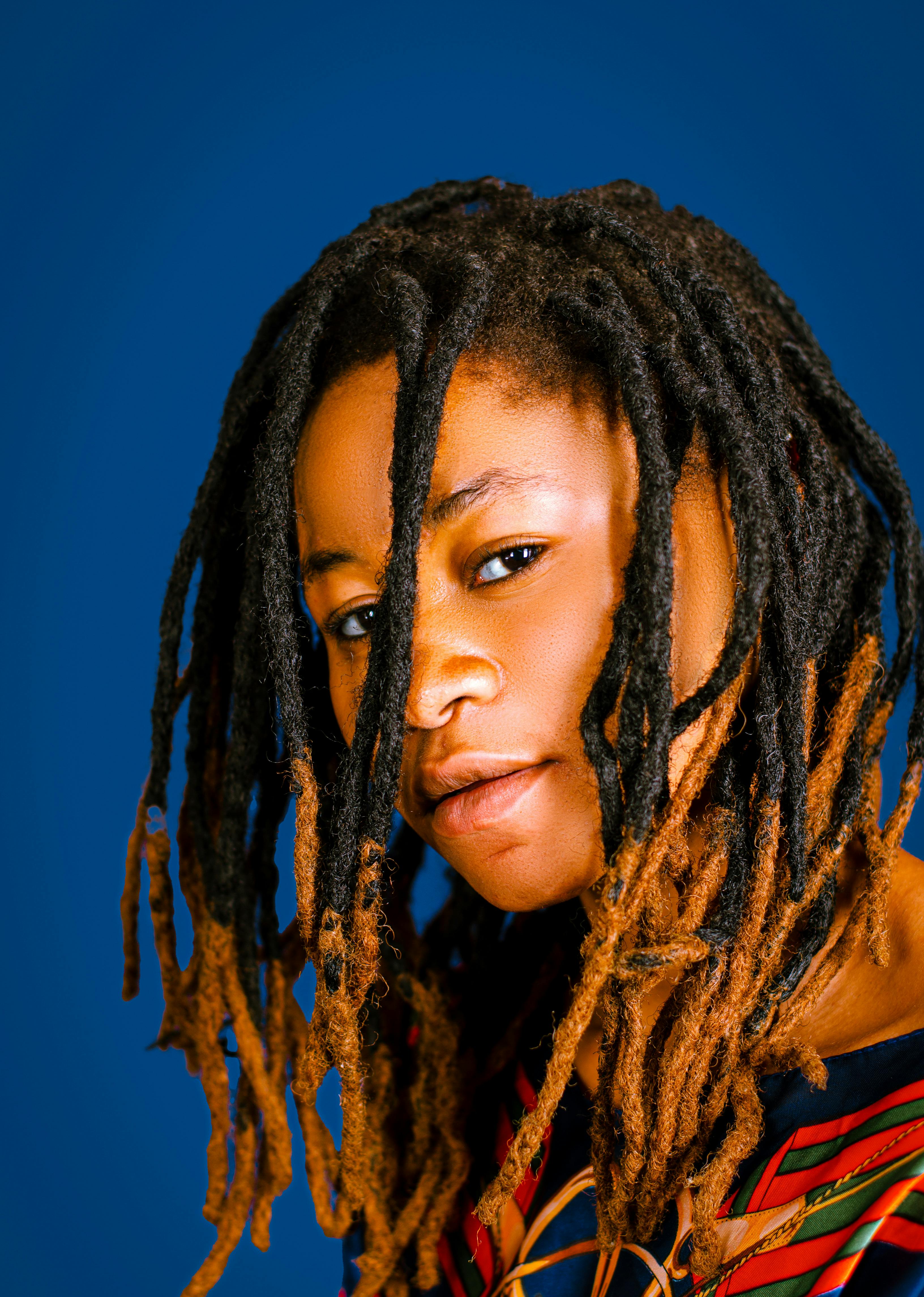 Woman Posing with Flowers on Body and Dreadlocks Hairstyle · Free Stock ...