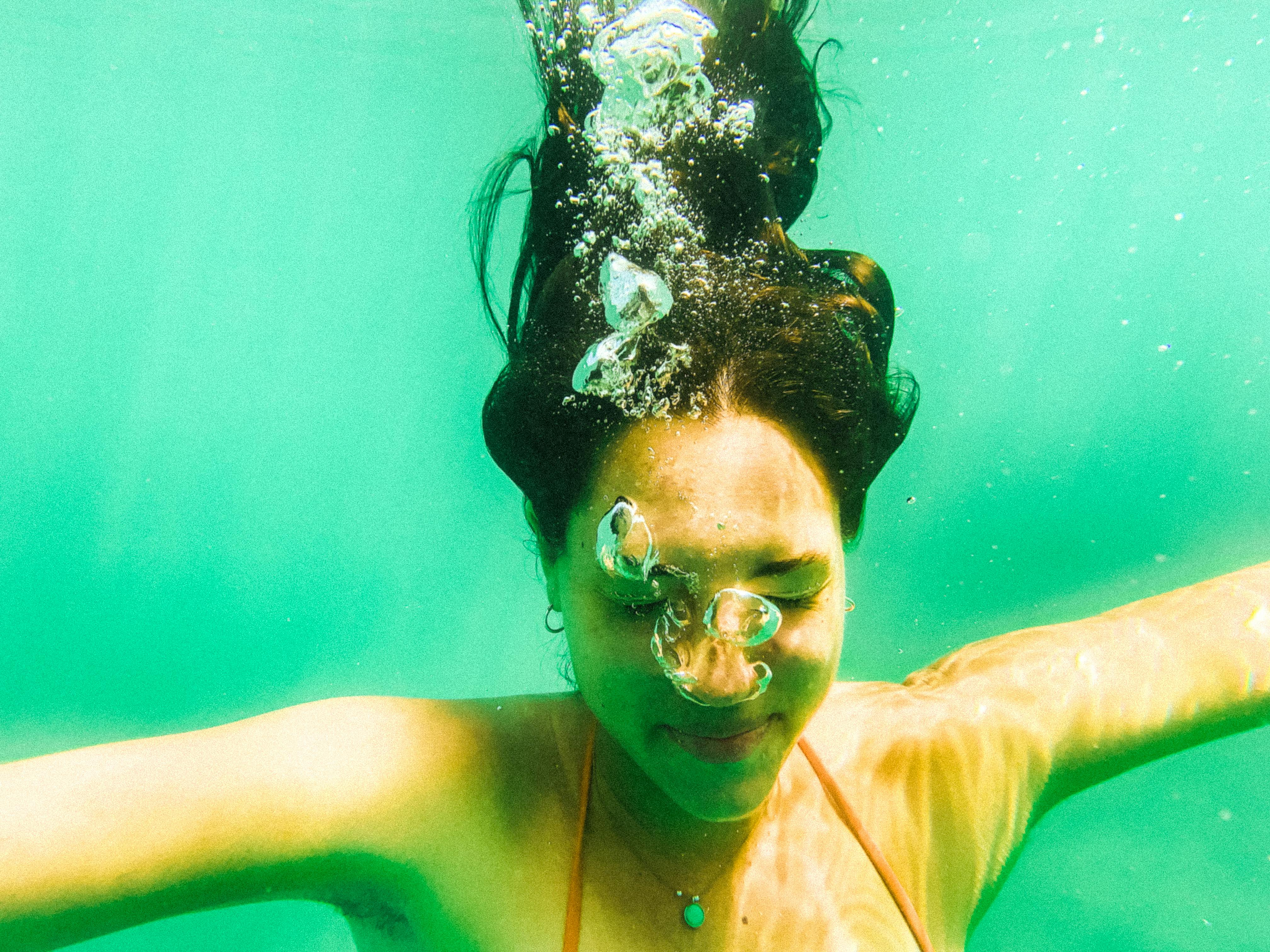 Underwater Photo of a Young Woman Holding Her Breath · Free Stock Photo