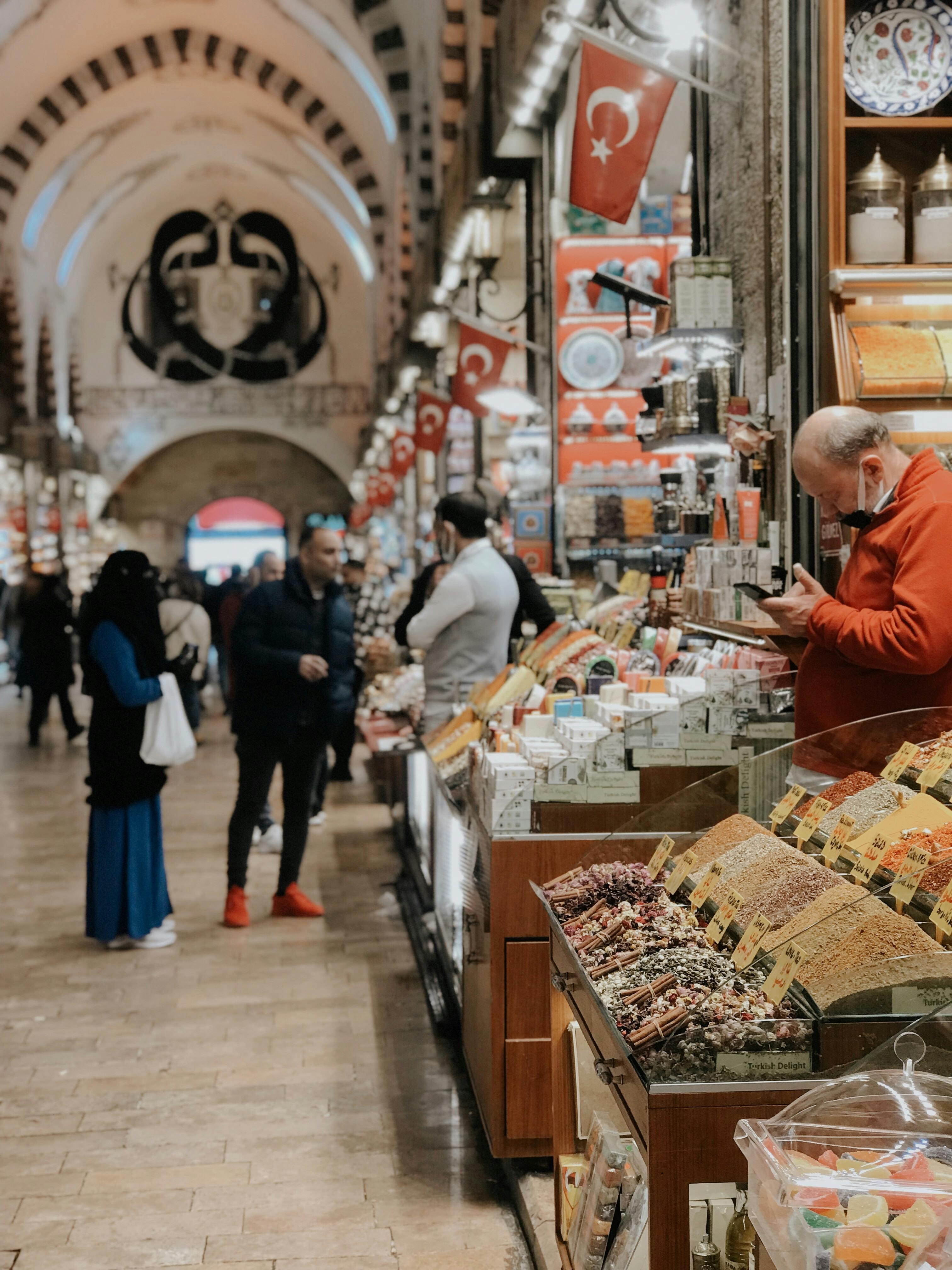 Merchant sitting in front of Shelves filled with Religious Figurines ...