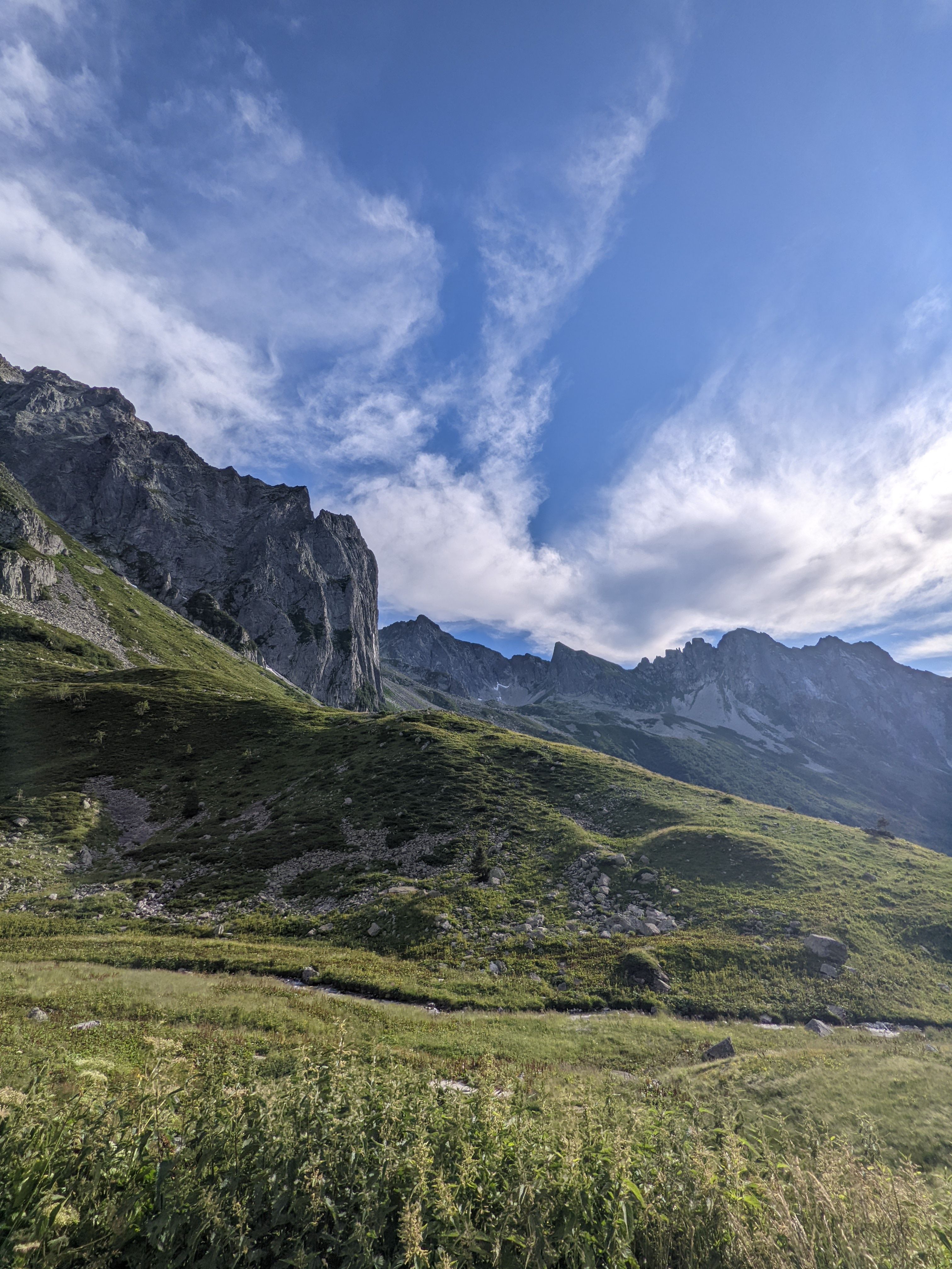 Low-Angle Shot of Mountains under the Cloudy Blue Sky · Free Stock Photo
