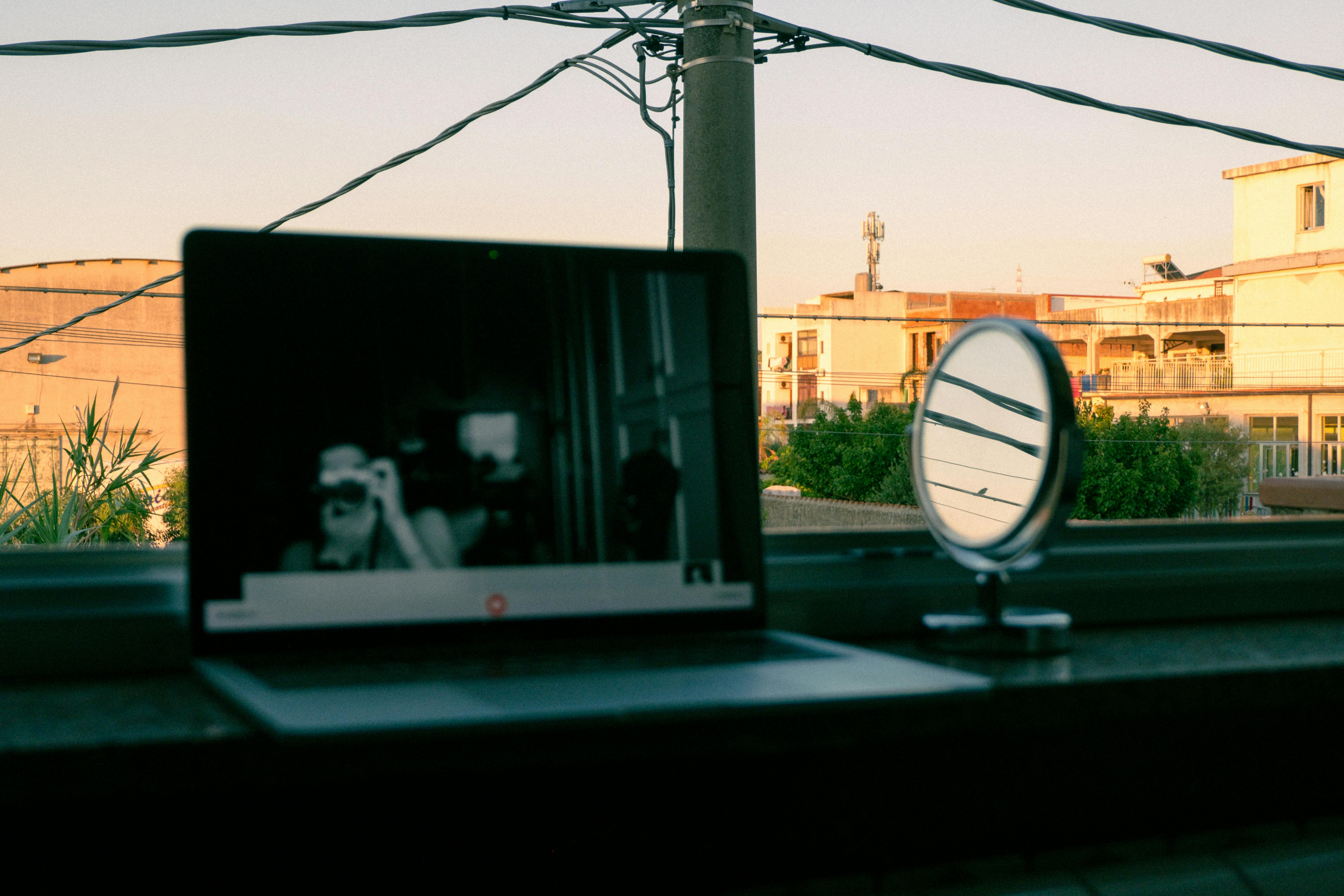 Laptop Beside a Mirror · Free Stock Photo