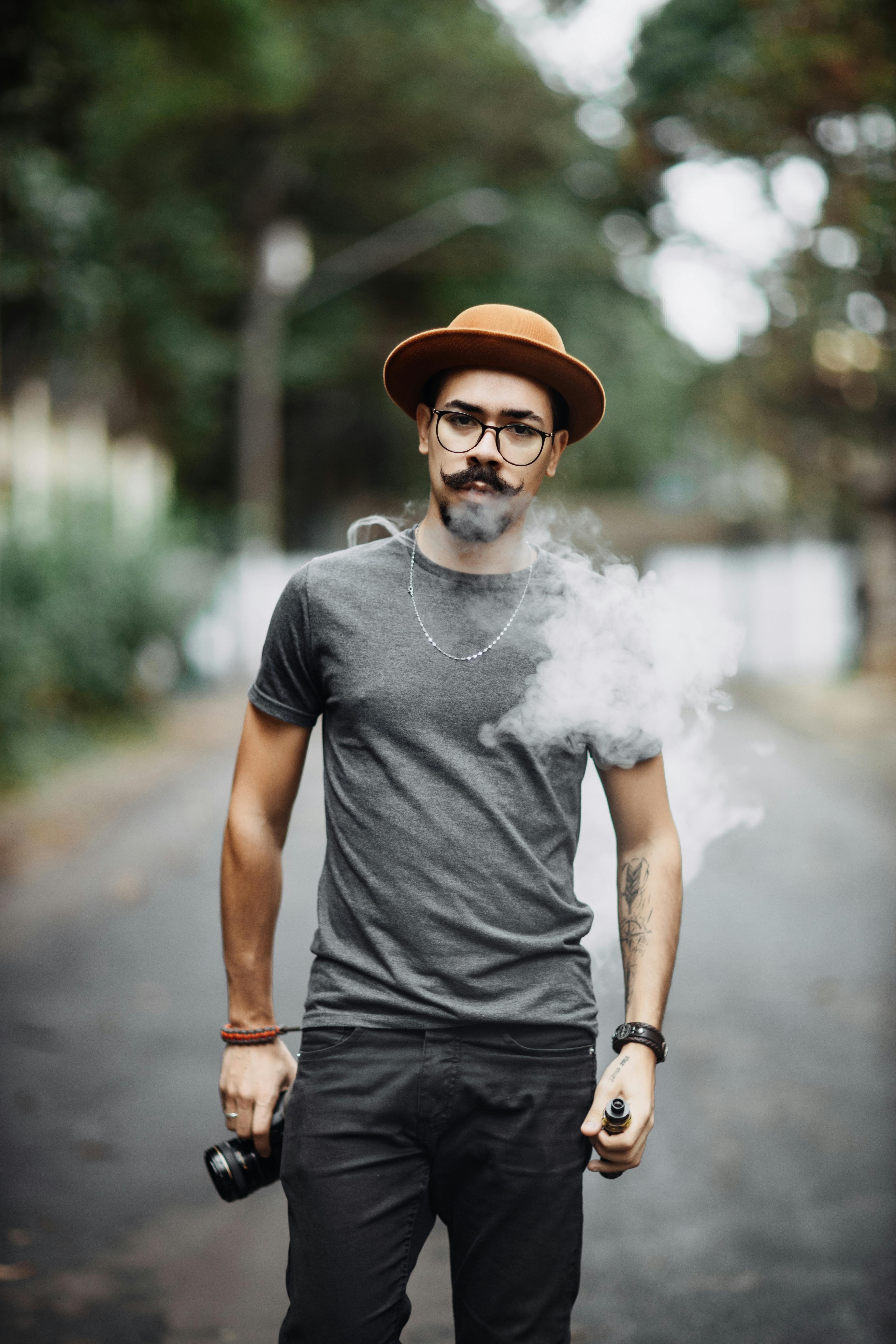 Portrait of Man Smoking on City Street · Free Stock Photo