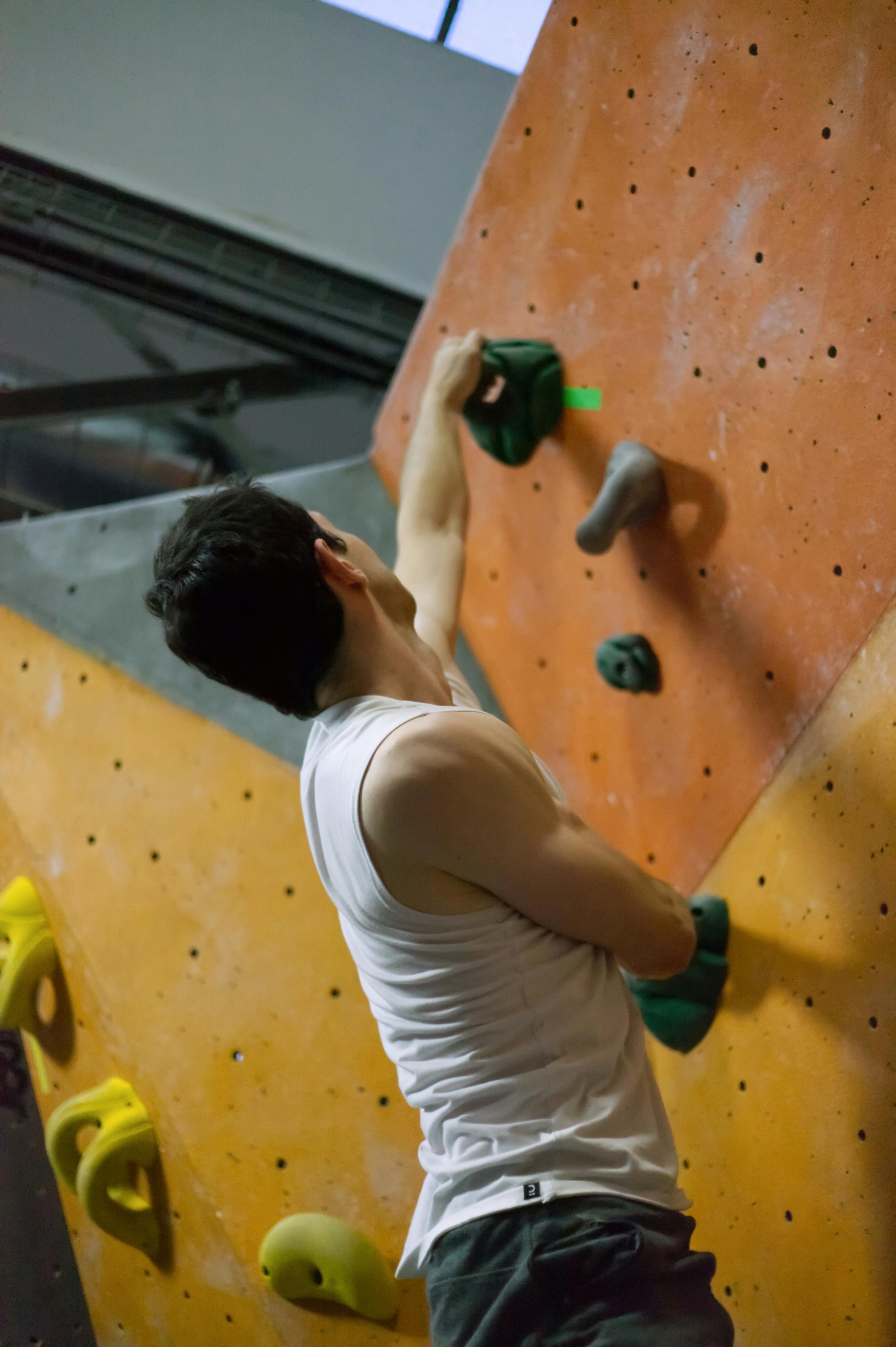Man in White Tank Top Rock Climbing · Free Stock Photo