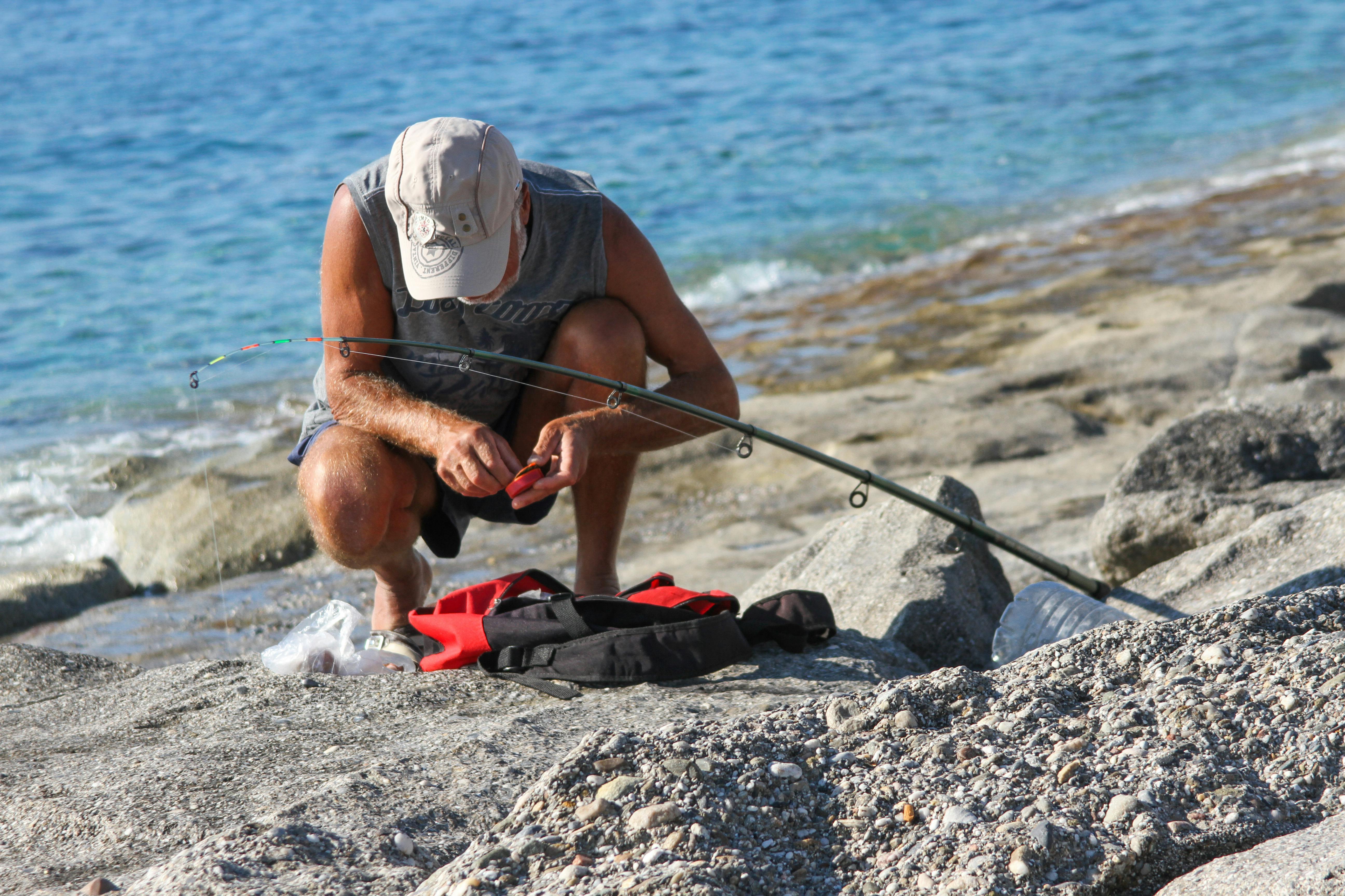 Person Holding a Fishing Rod · Free Stock Photo