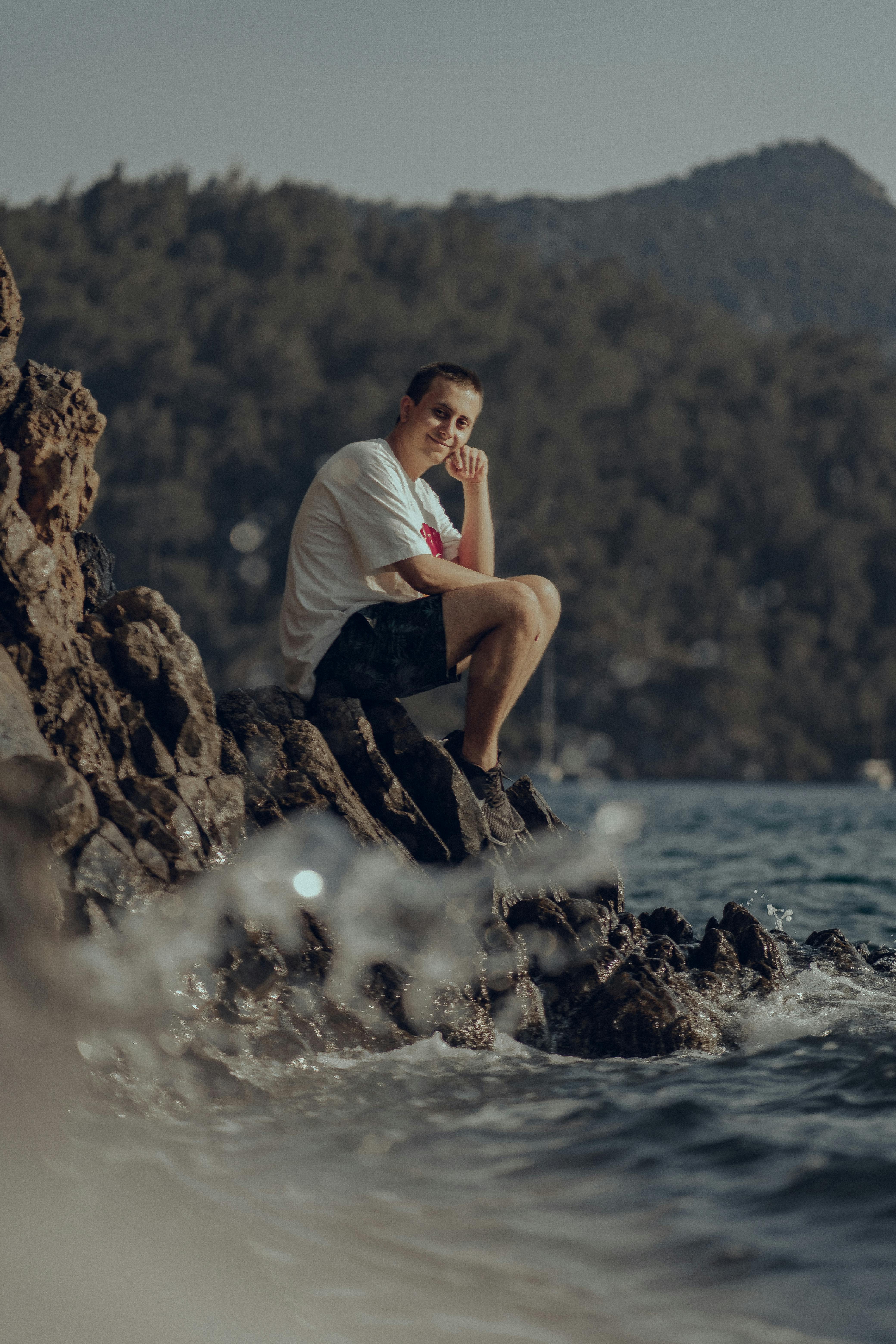 A Man Sitting on the Rock · Free Stock Photo