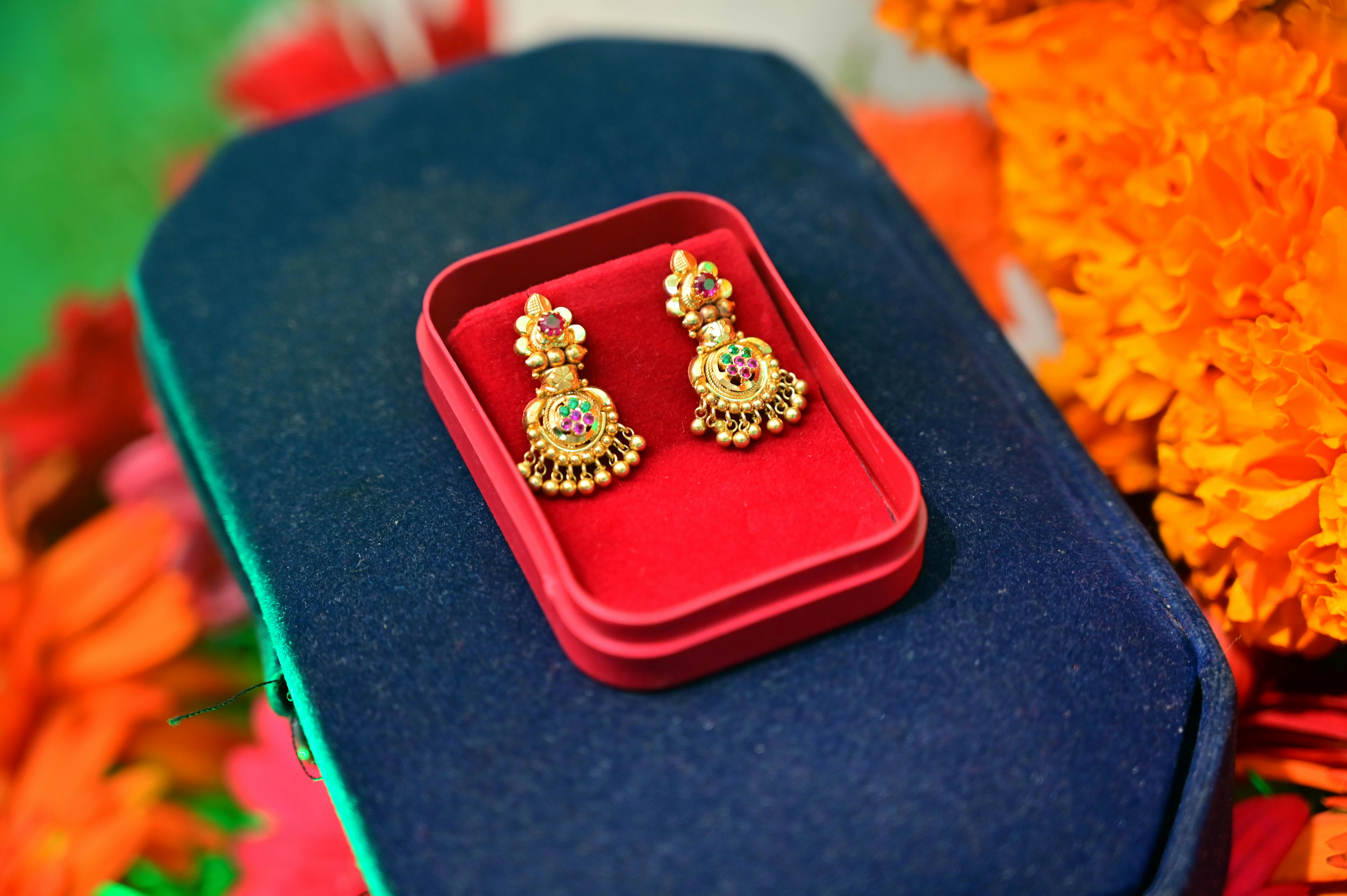 A Woman with Wavy Hair Wearing Gold Earring · Free Stock Photo