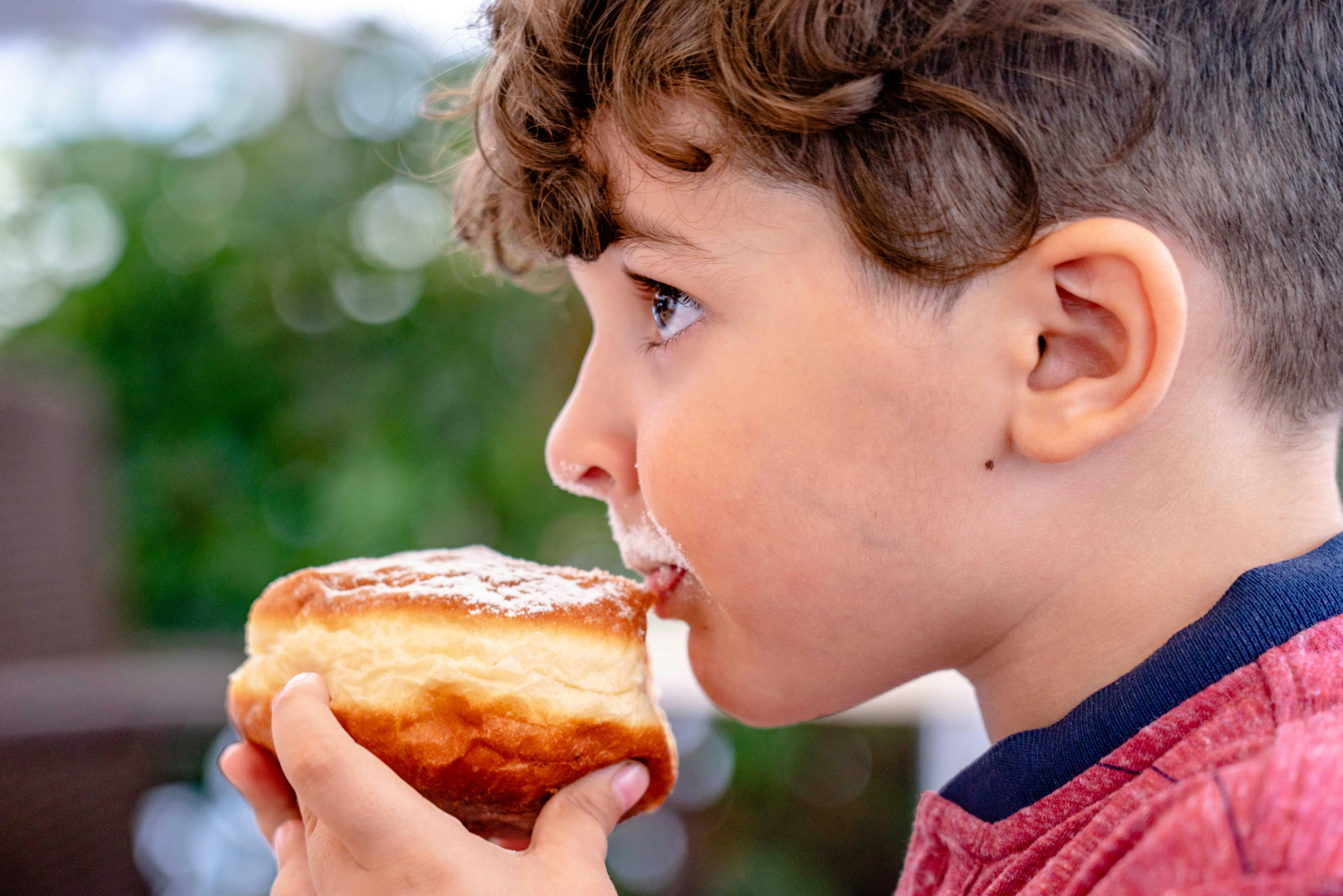 Boy Eating Bread in Close Up Photography · Free Stock Photo