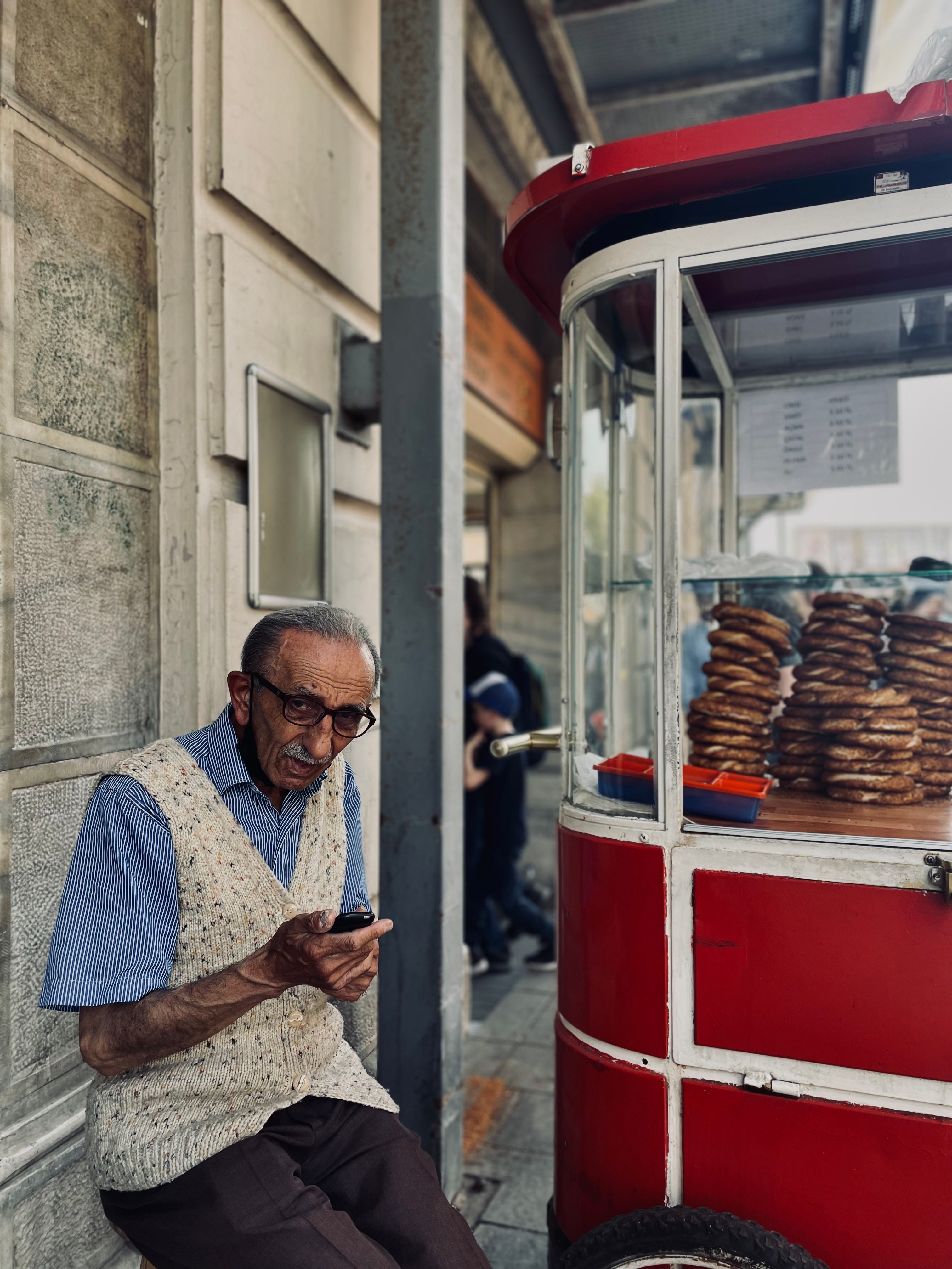 man Sitting Beside a Food Cart · Free Stock Photo