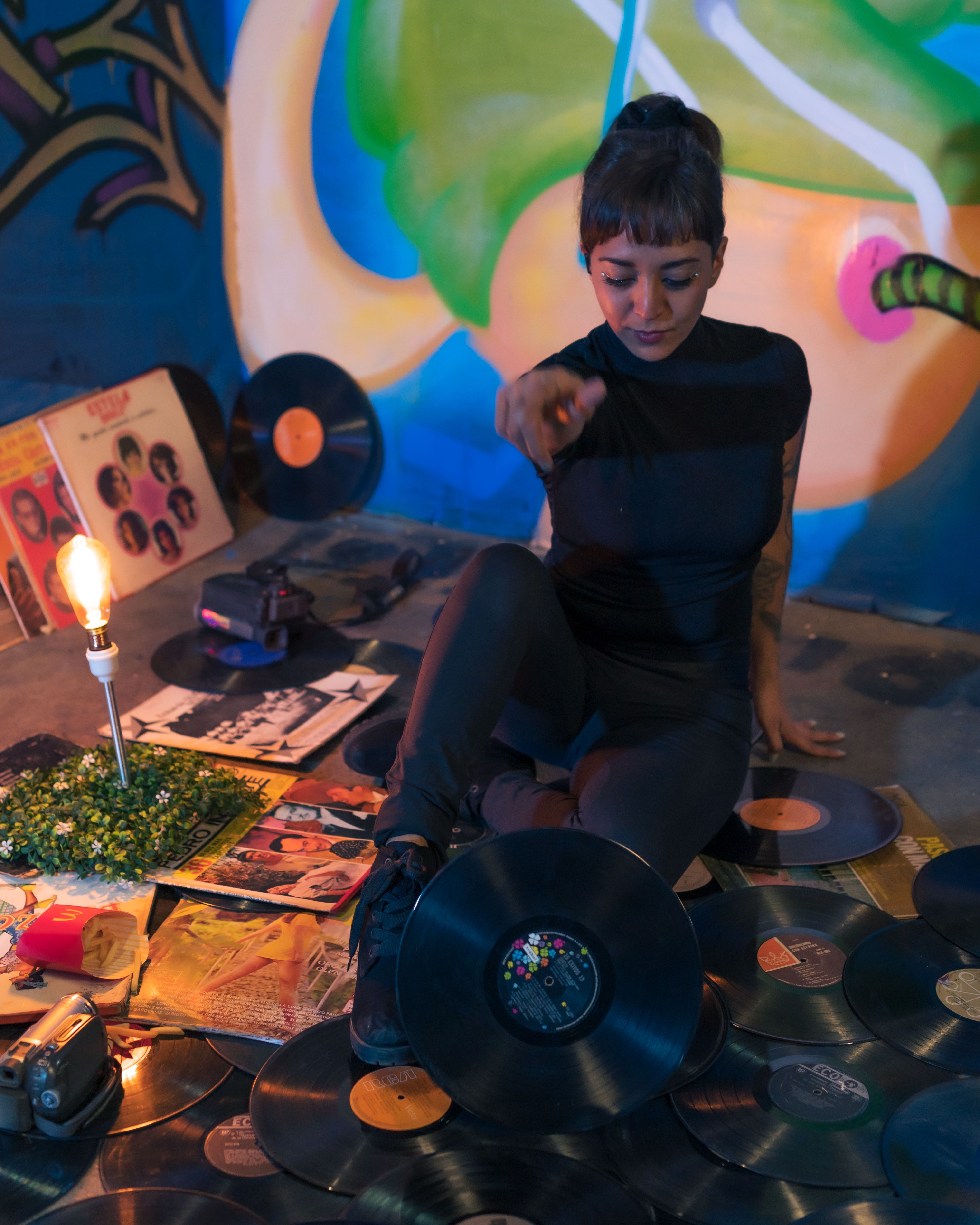 Woman Dressed in Black Sitting on the Floor Among Scattered Vinyl ...