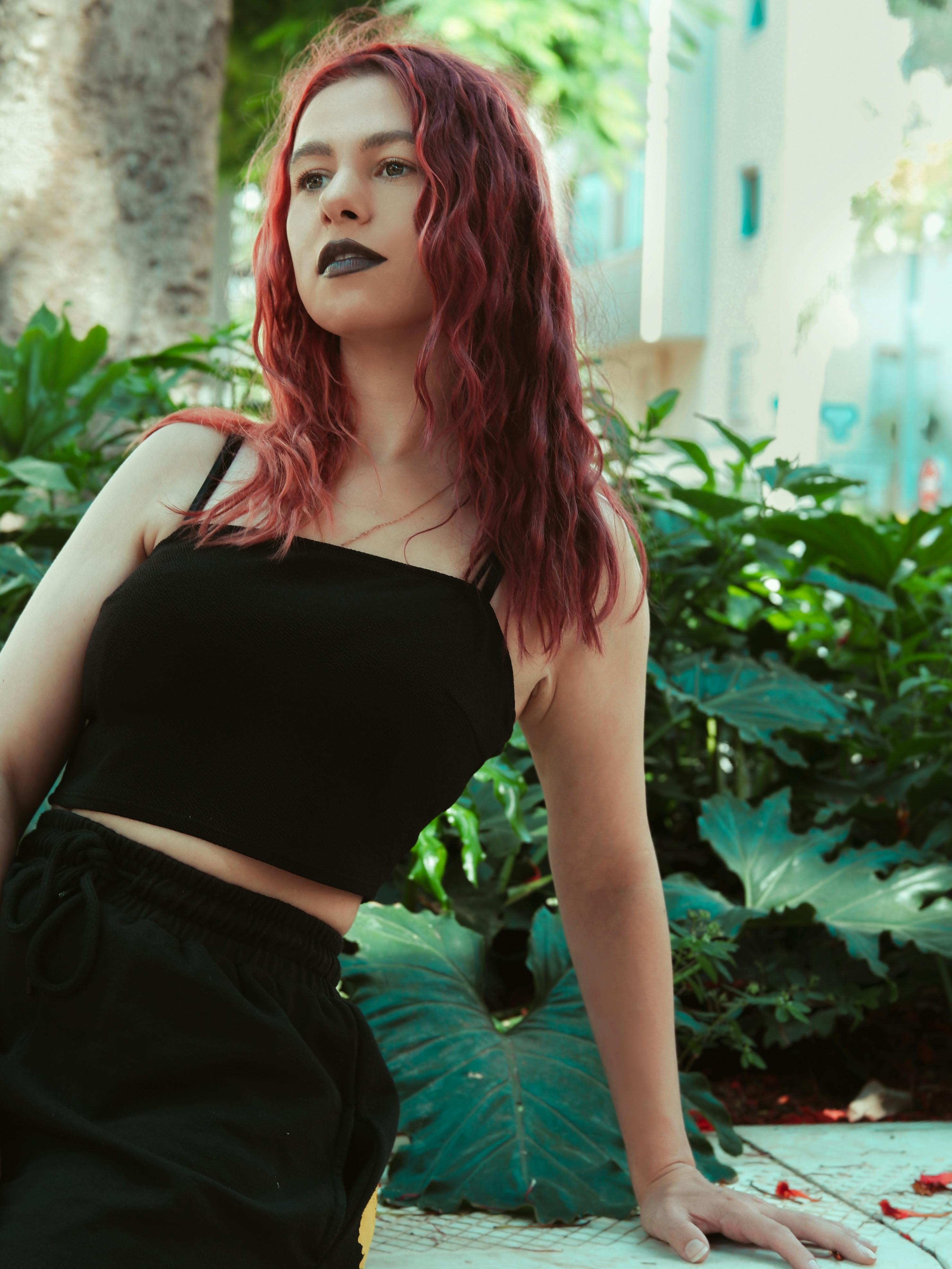 A Topless Woman Posing by the Seaside · Free Stock Photo