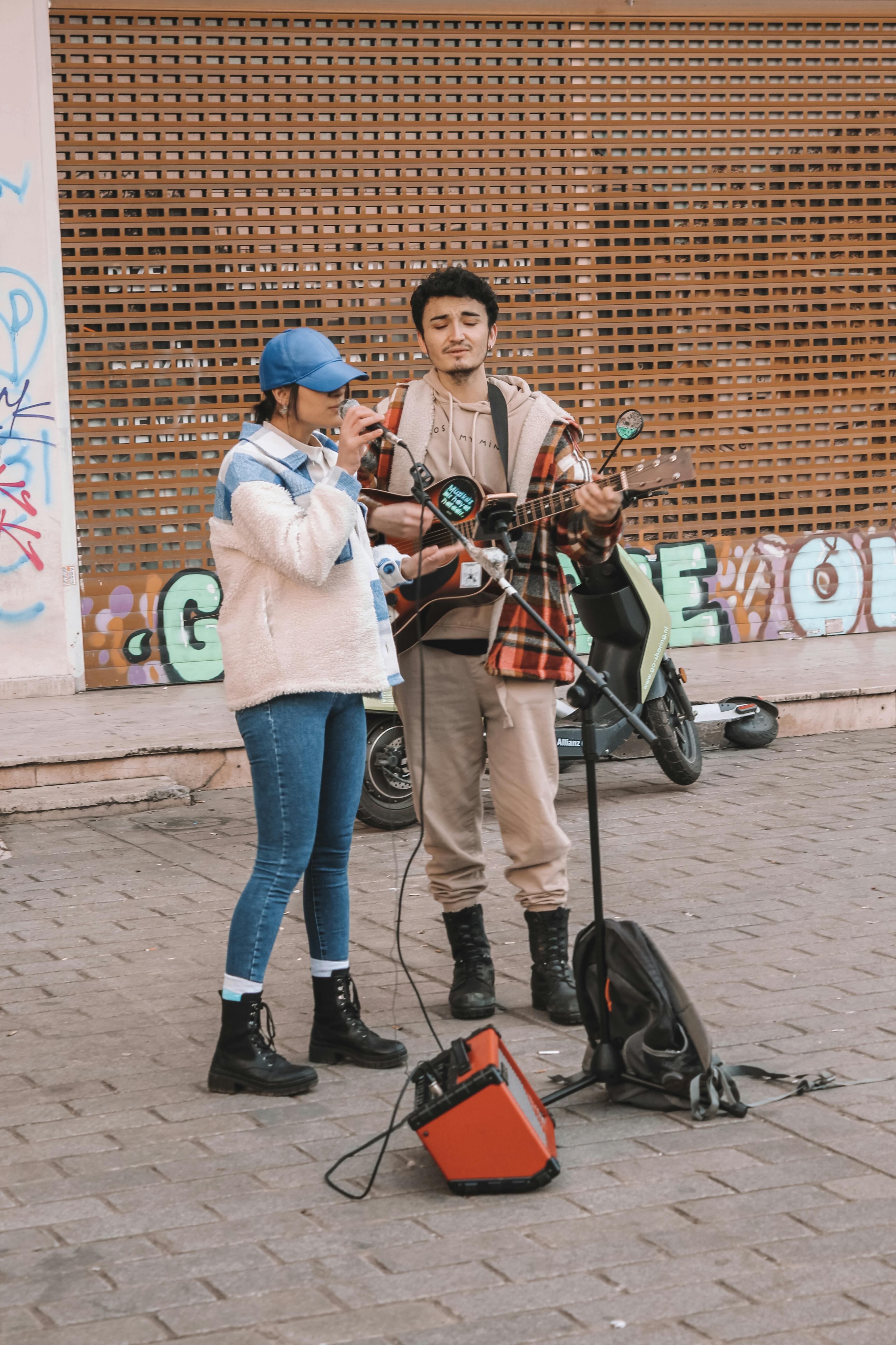 Man and Woman Busking on the Street · Free Stock Photo
