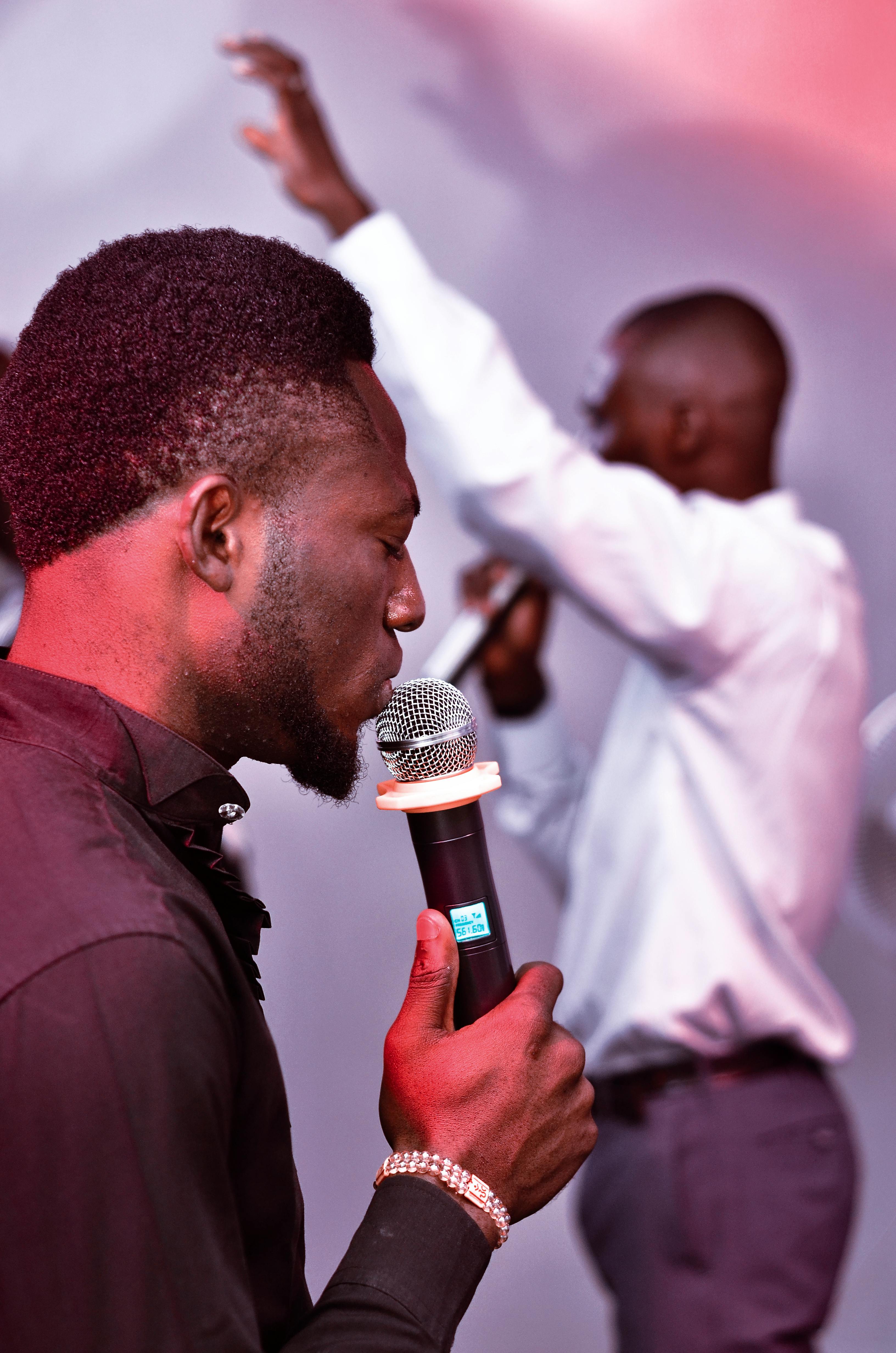 Man Speaking through Microphone During Religious Ceremony · Free Stock ...