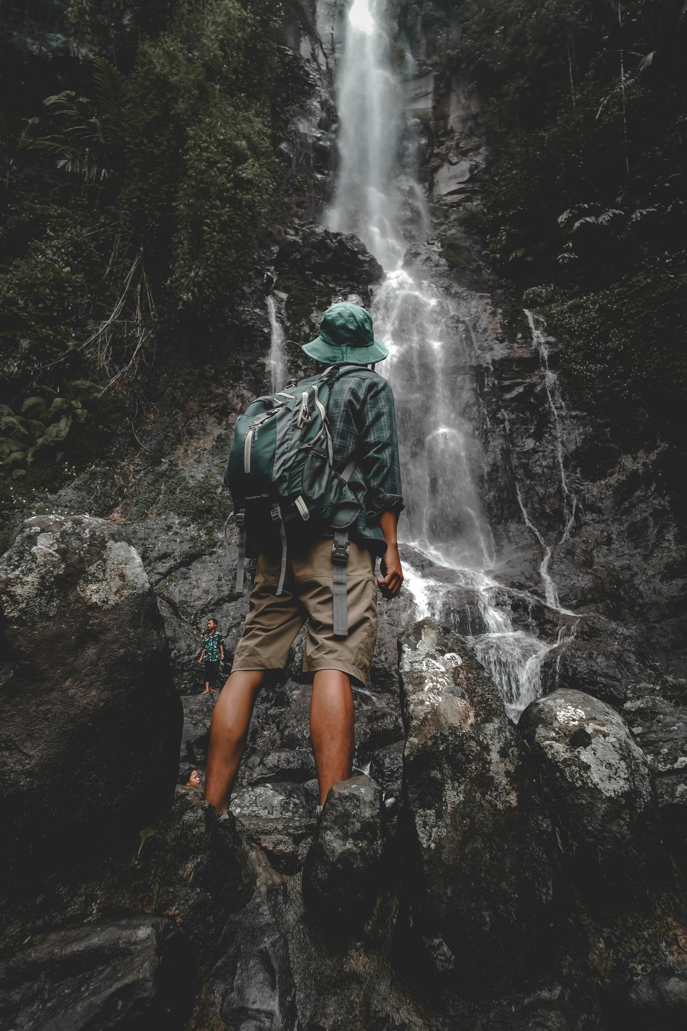 Person Standing on the Waterfall · Free Stock Photo