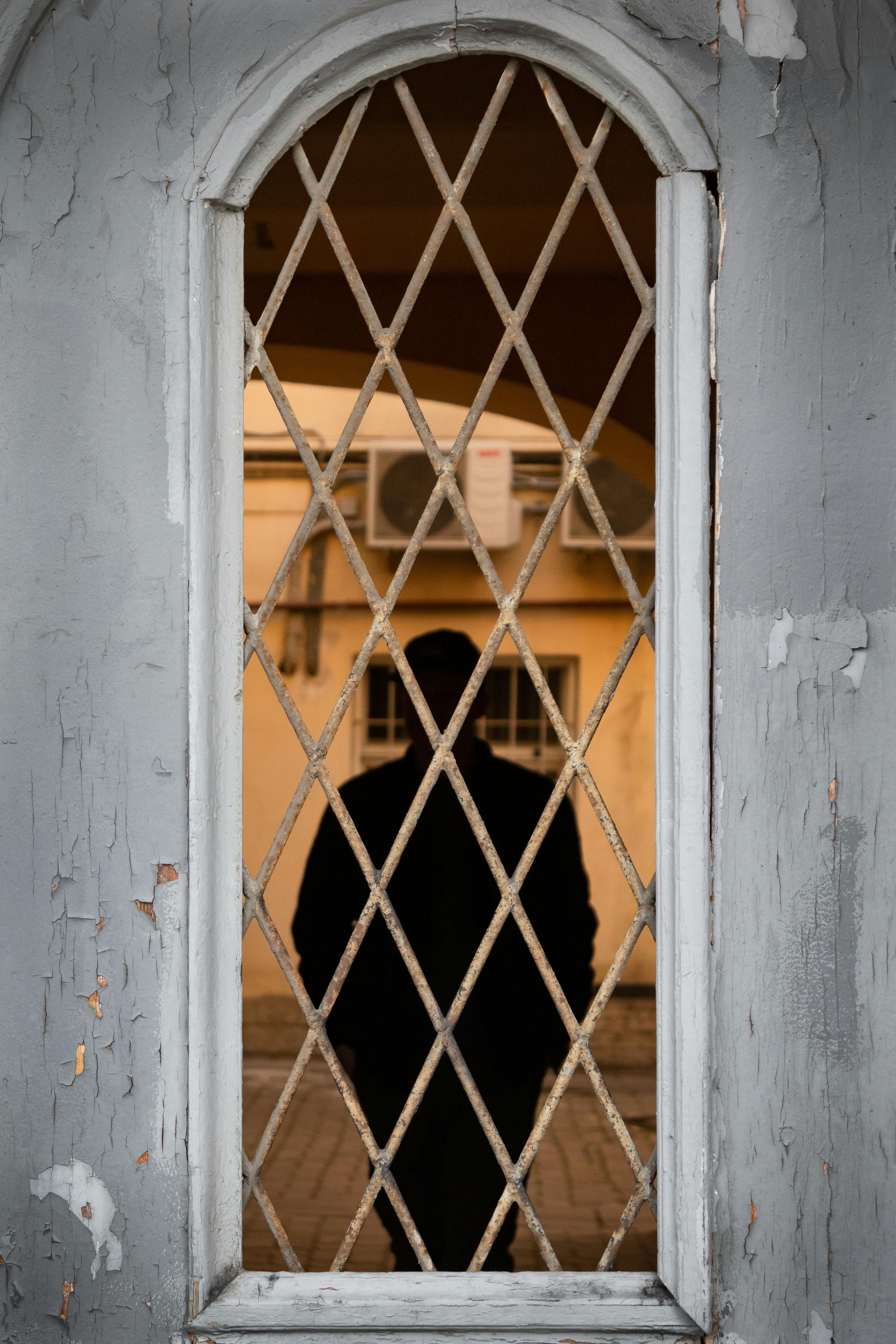 A Person Standing Behind the Window · Free Stock Photo