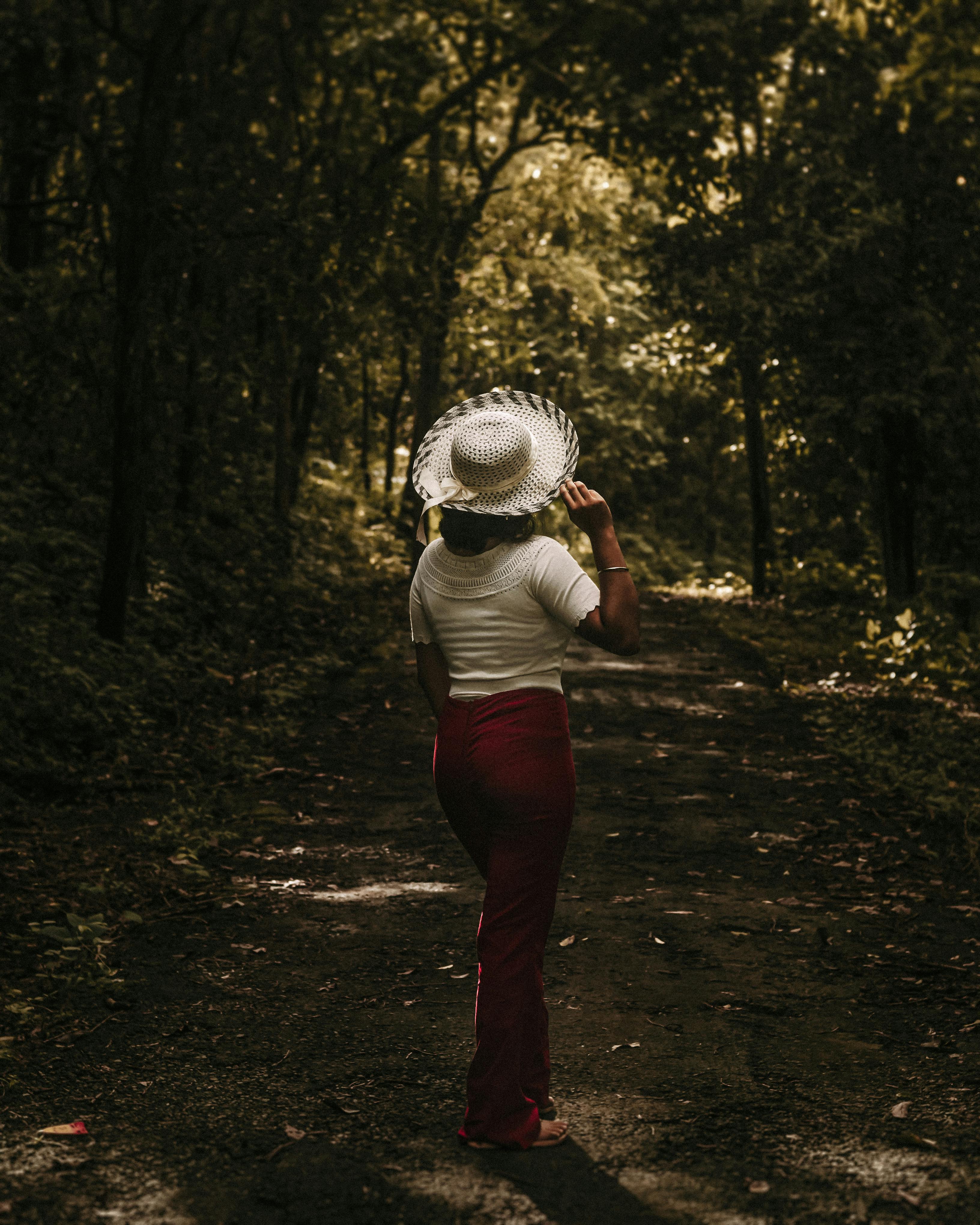 Back View of a Woman Wearing a Straw Hat · Free Stock Photo
