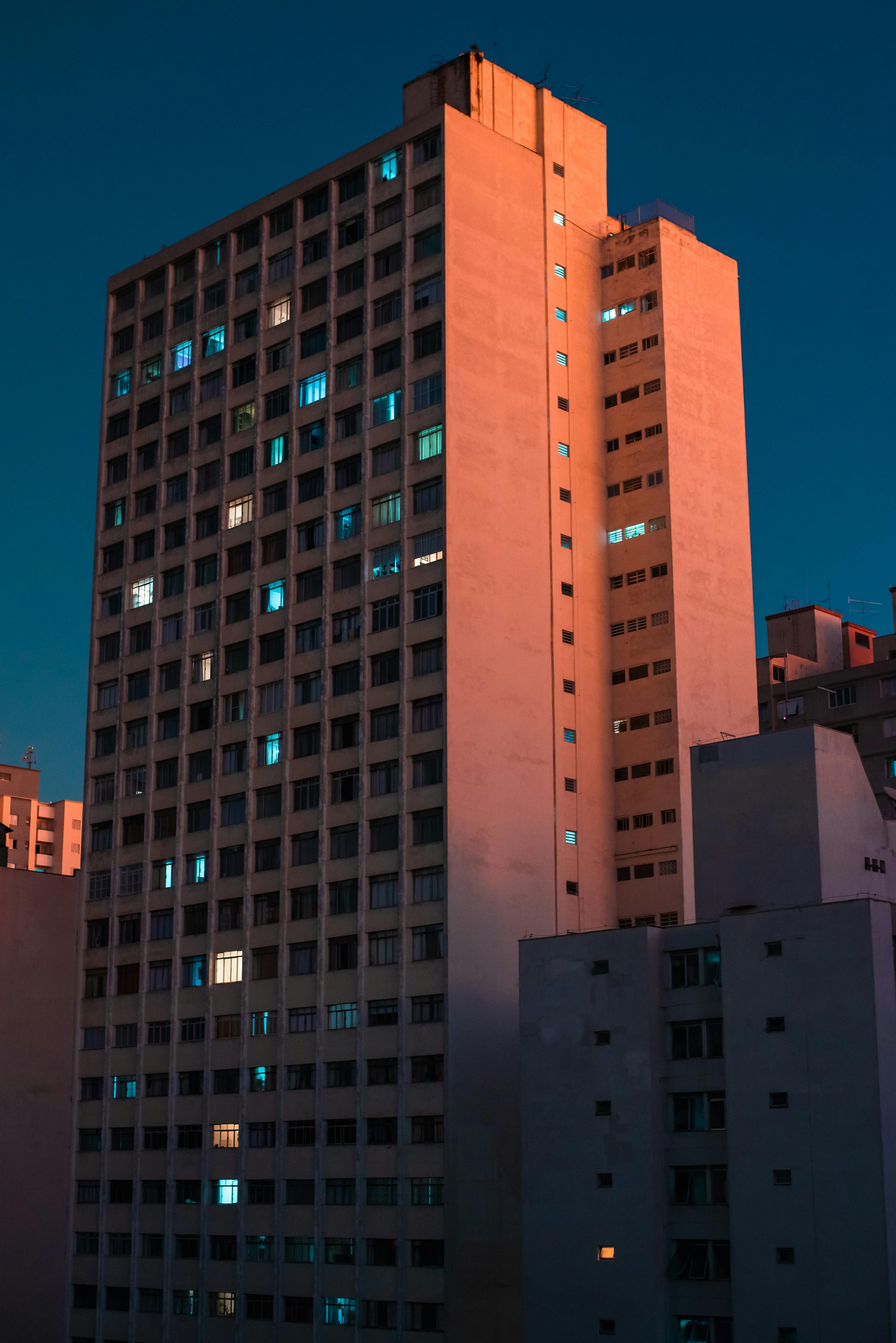 High Rise Concrete Building Under Evening Skies · Free Stock Photo
