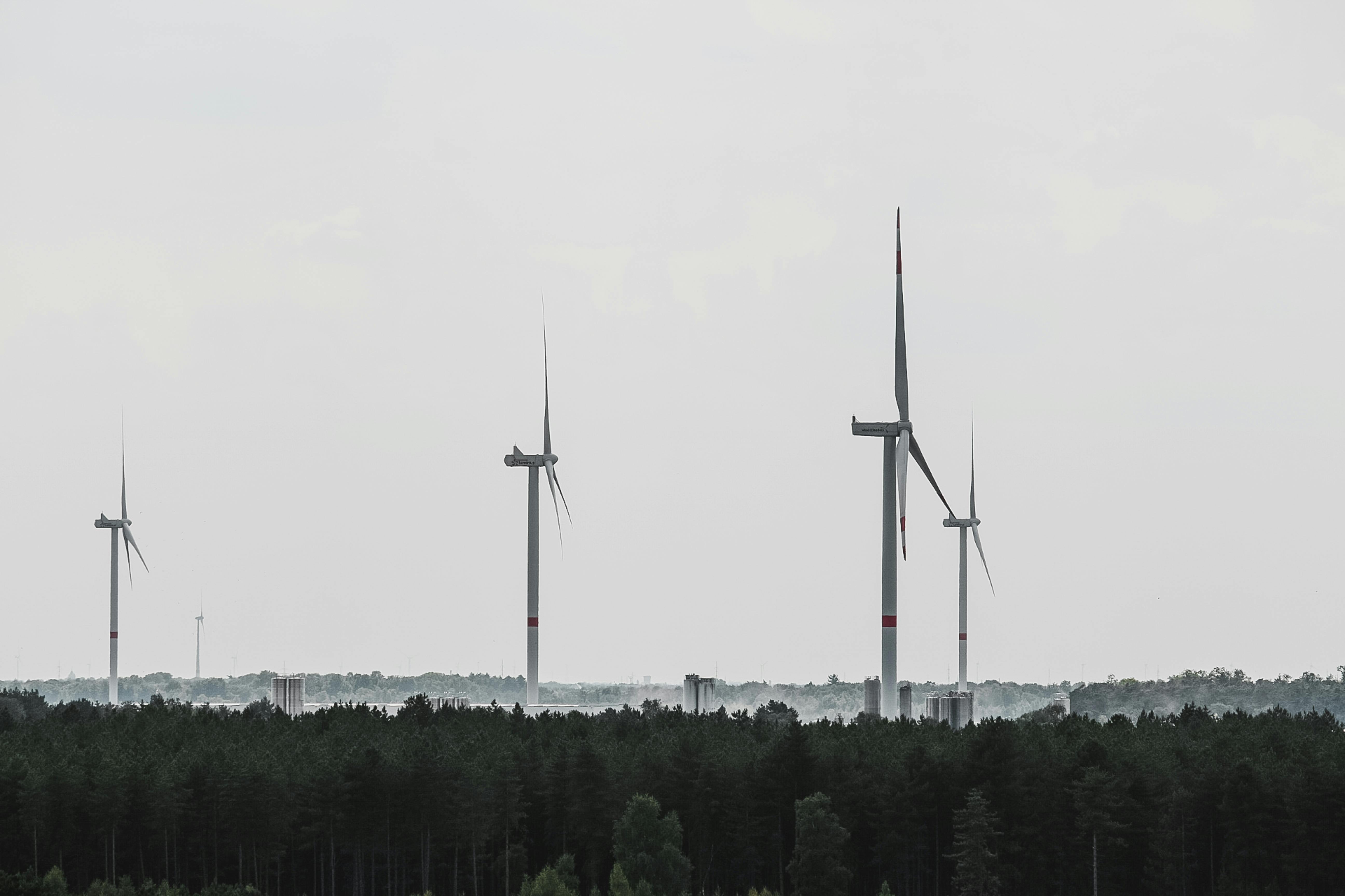A Grayscale Photo of a Windmill Under a Cloudy Sky · Free Stock Photo