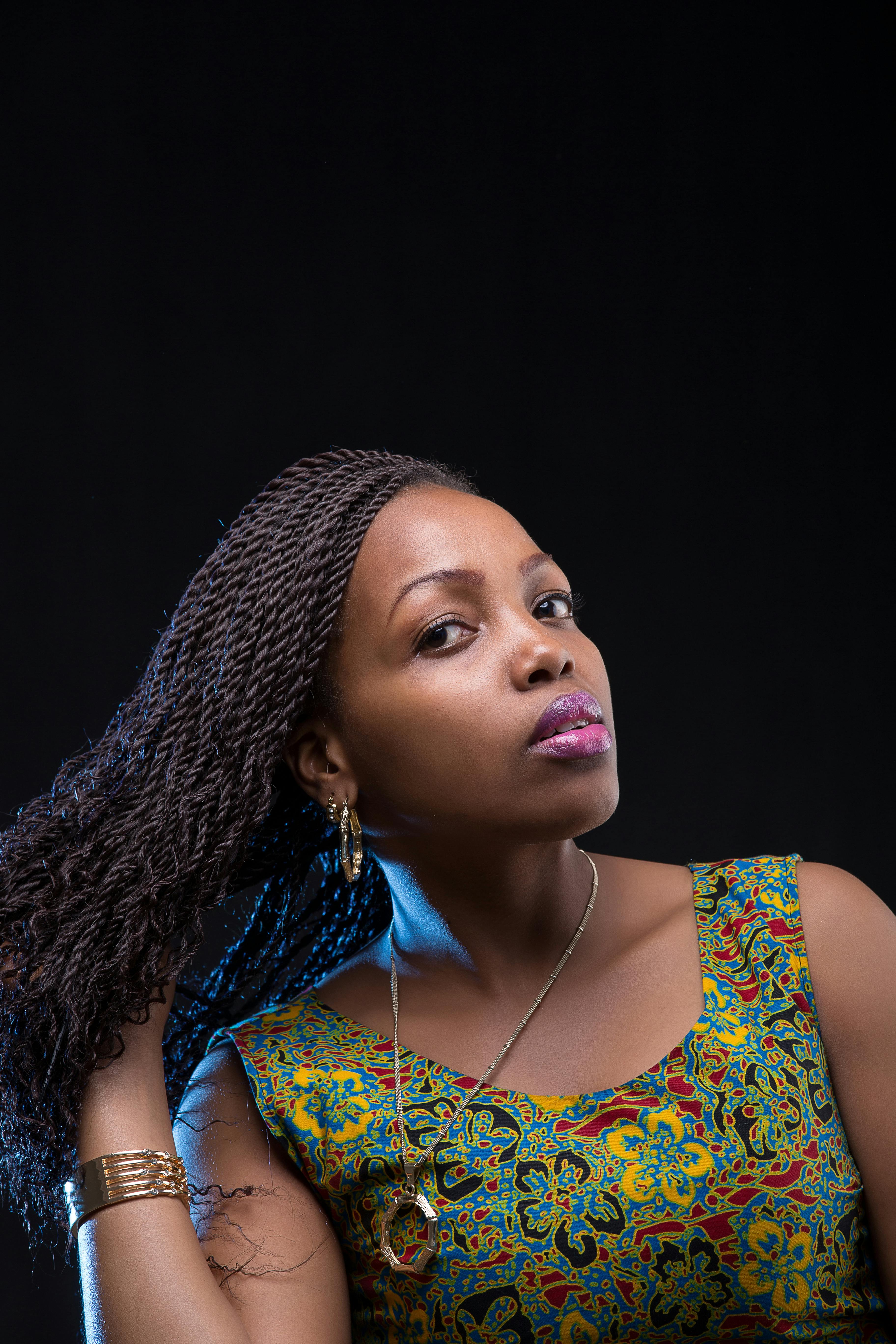 A Woman Sitting while Leaning on the Wall · Free Stock Photo