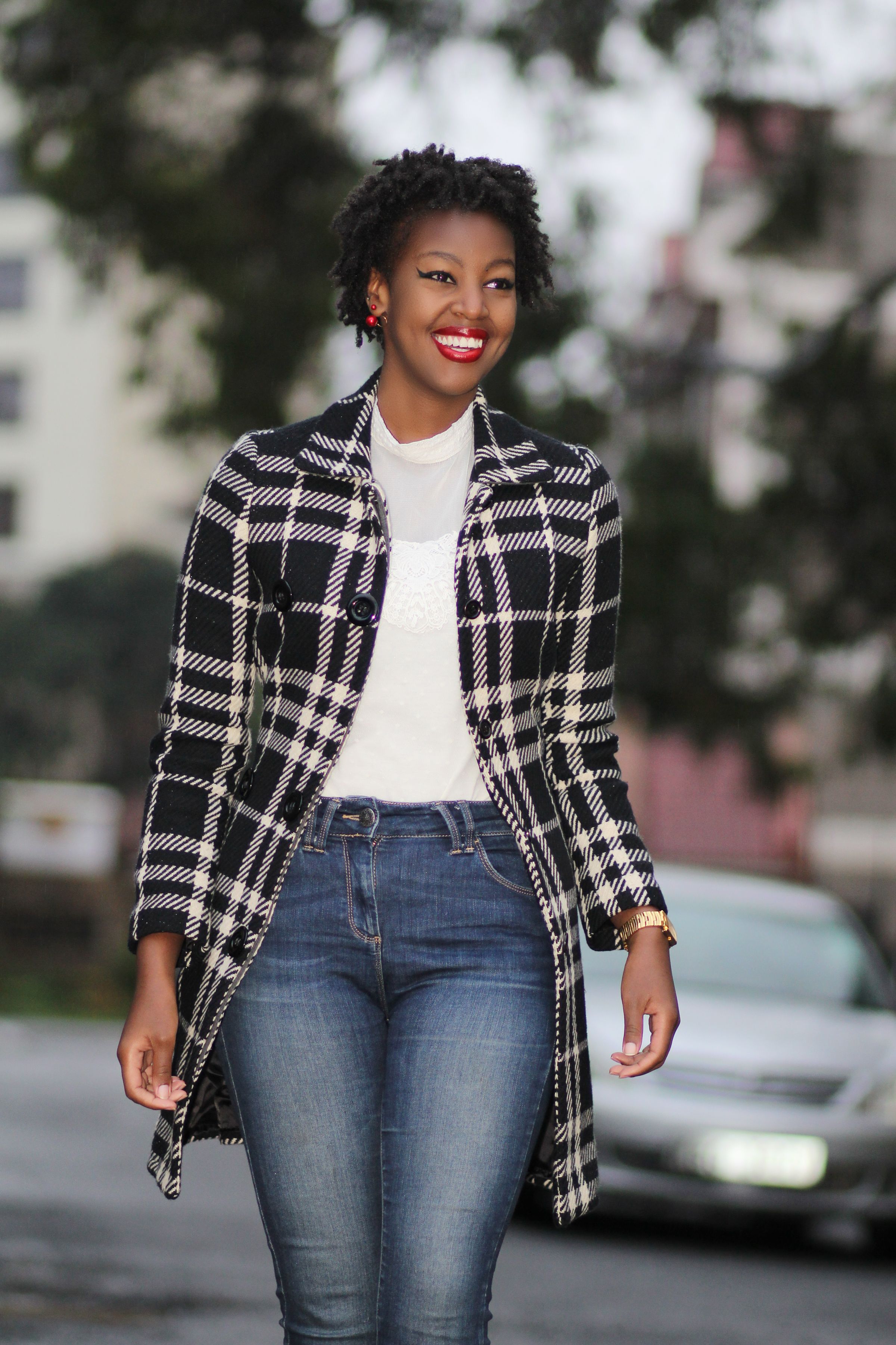 Photo of a Woman in a Black and White Checked Coat · Free Stock Photo