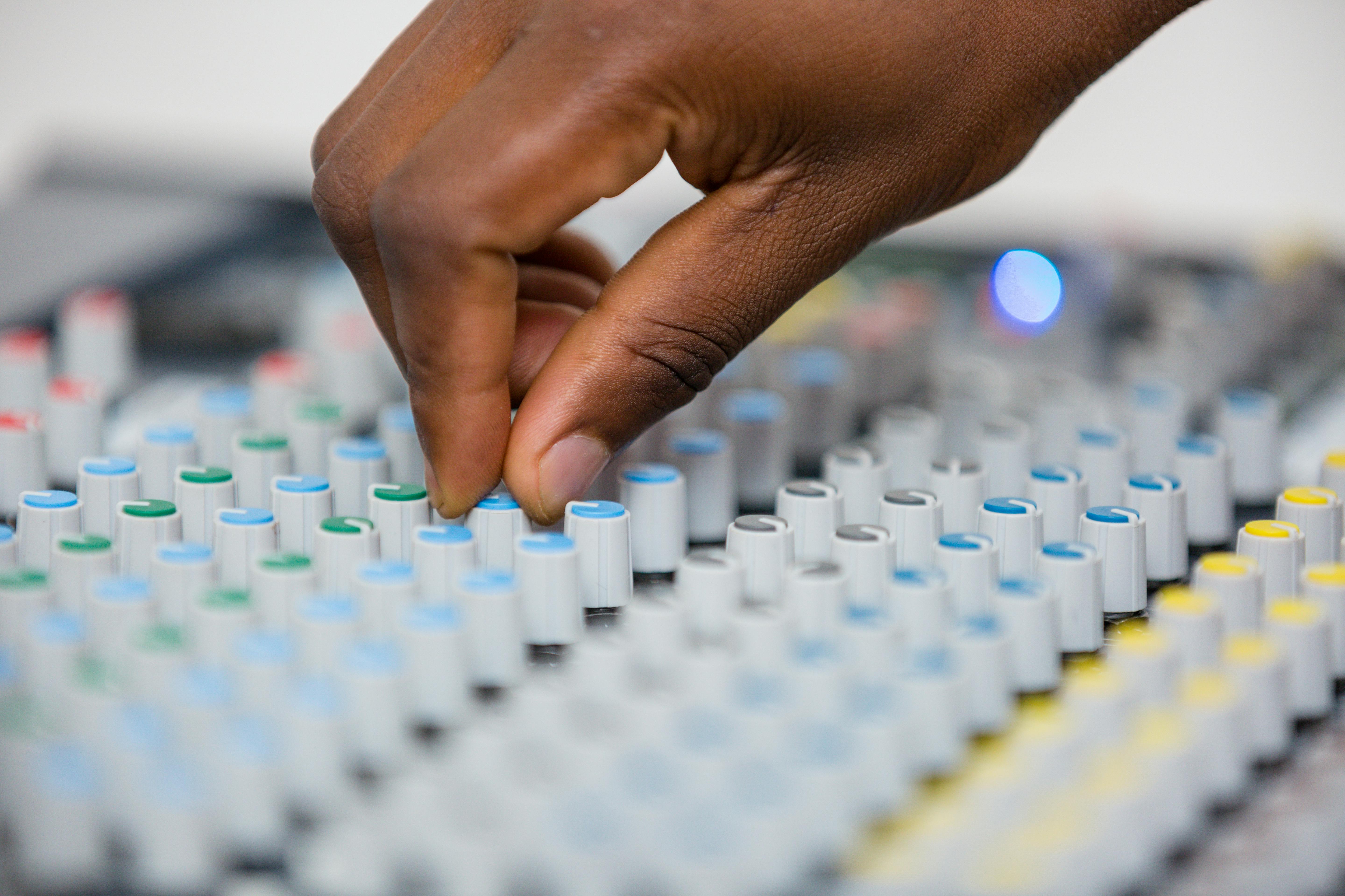 Hand Operating Sound Mixing Console · Free Stock Photo