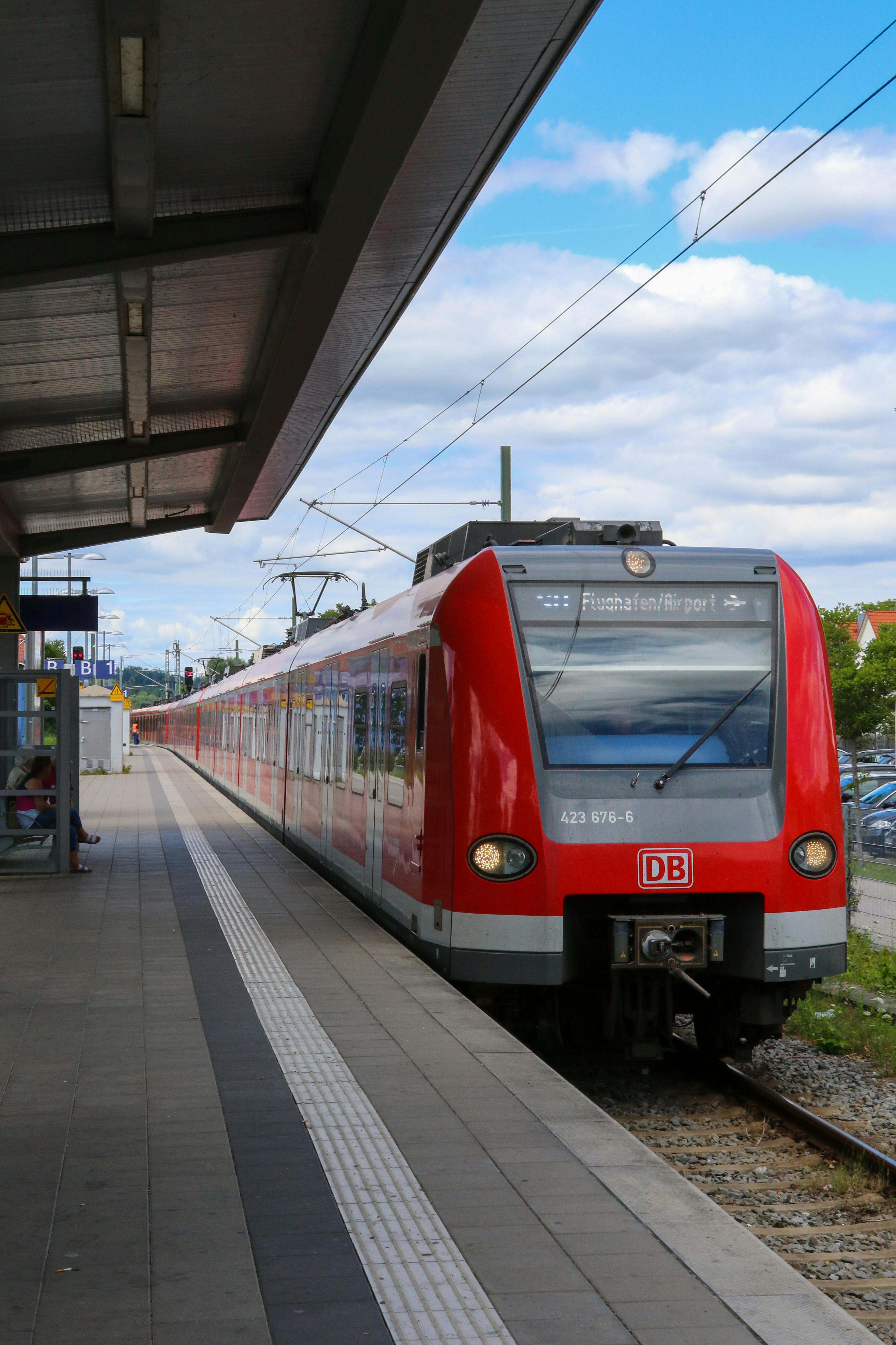 Red and Gray Train on Rail Tracks · Free Stock Photo