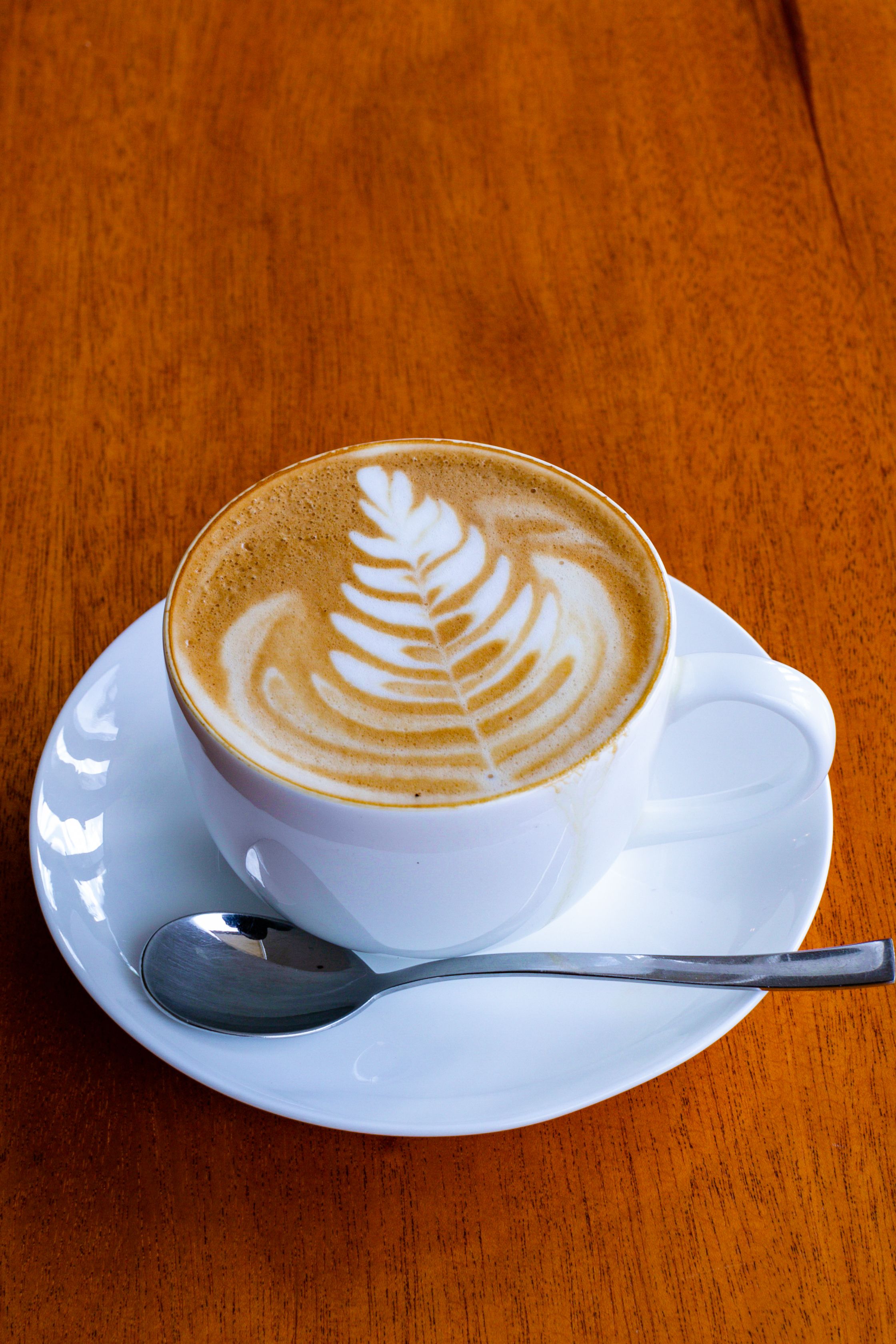Photo of a Saucer with a Cup of Coffee and a Teaspoon · Free Stock Photo