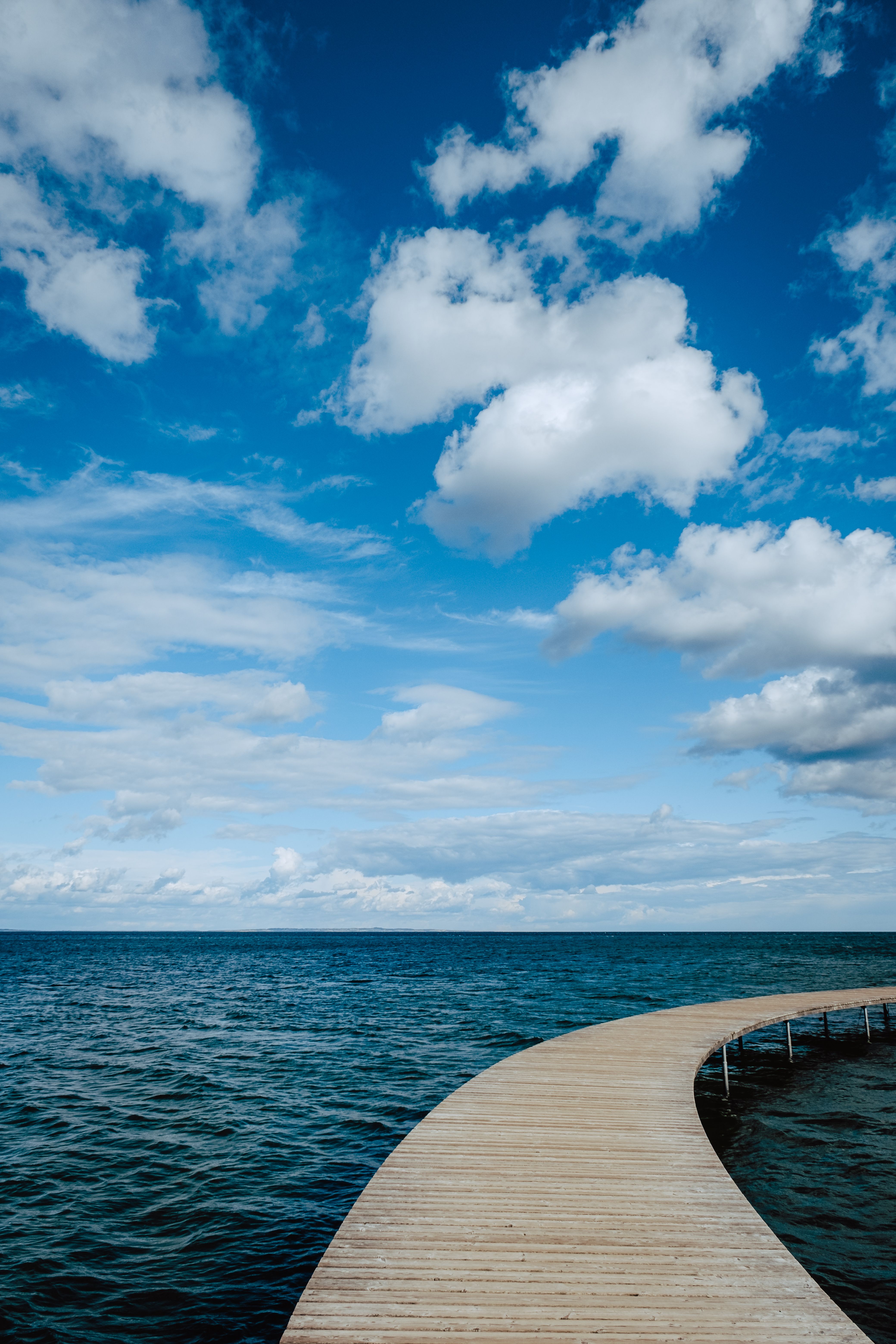Photo of a Dock on the Sea Under the Cloudy Sky · Free Stock Photo
