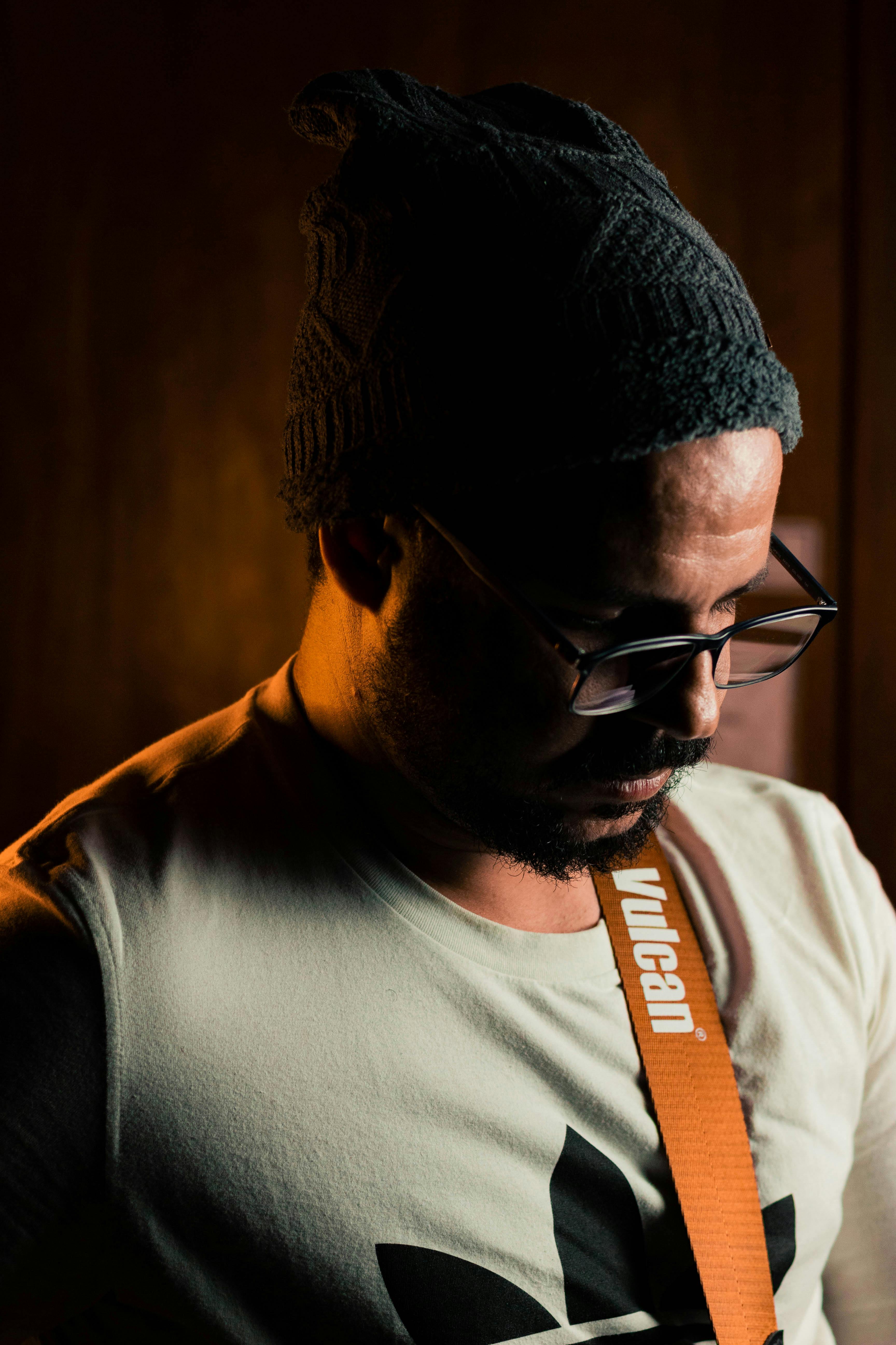 A Man Wearing a Kimono Jacket and a Bonnet on a Roof · Free Stock Photo