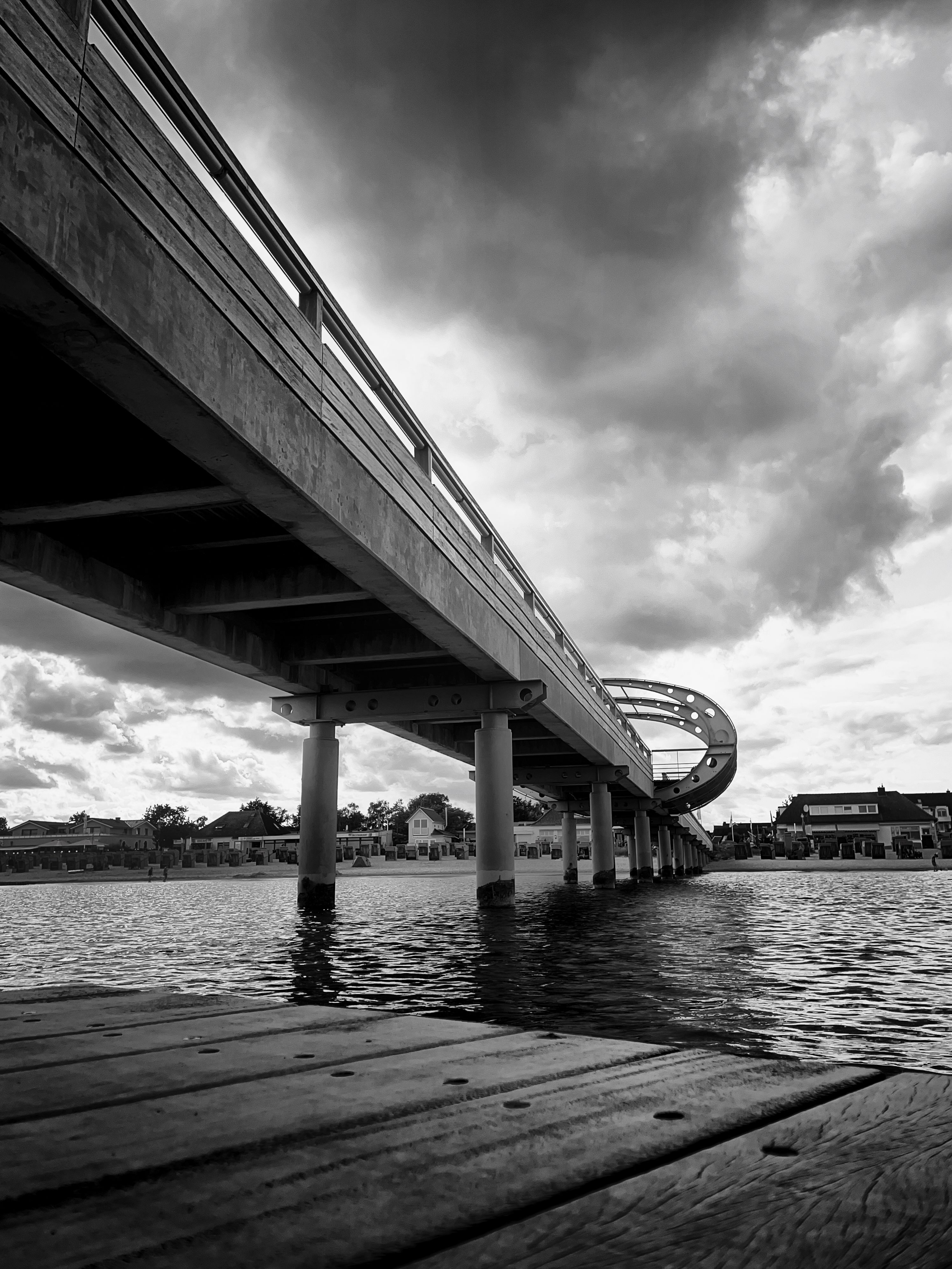 A Grayscale of a Bridge under a Cloudy Sky · Free Stock Photo