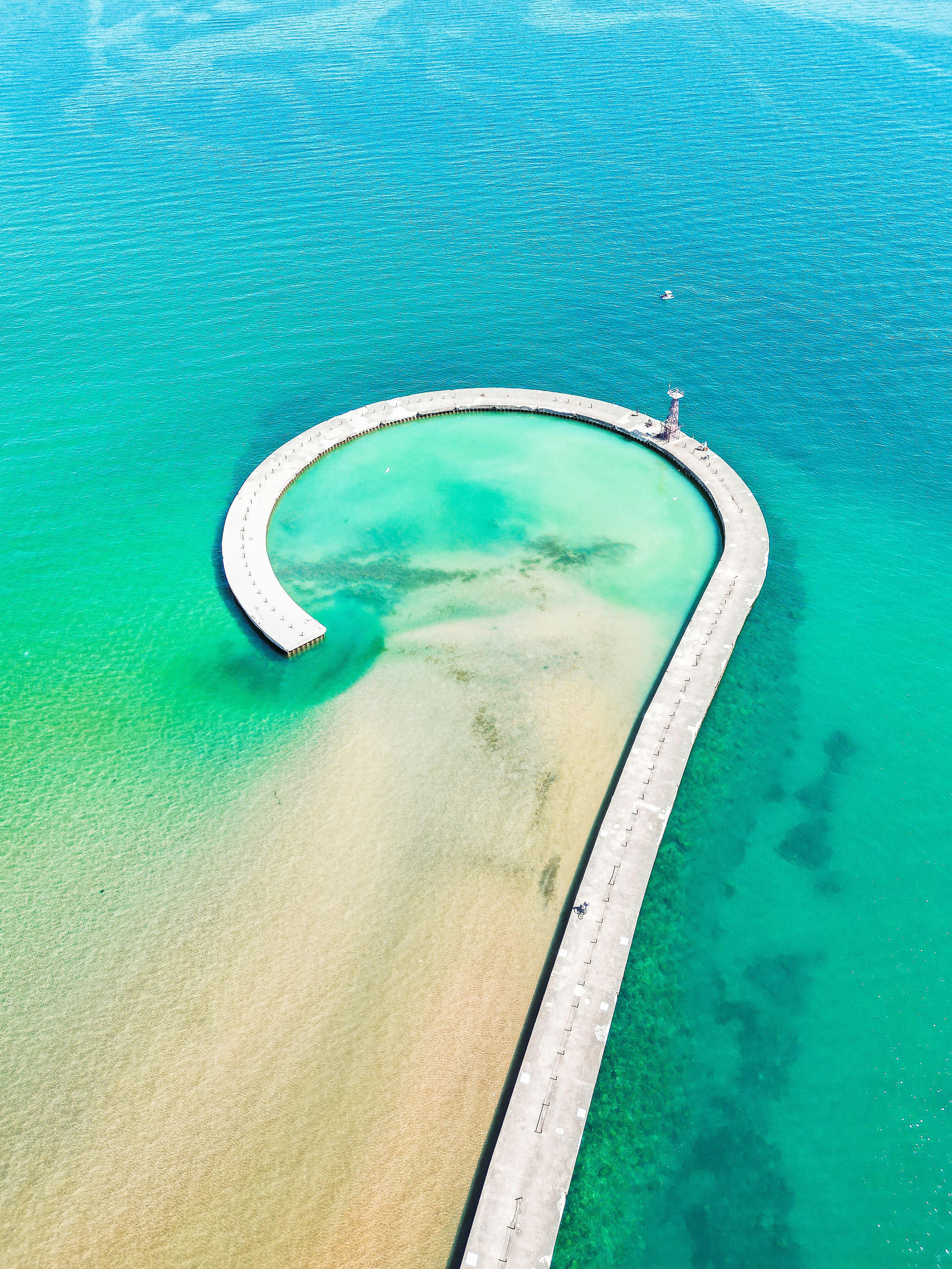 Aerial View of Concrete Dock on Blue Waters · Free Stock Photo
