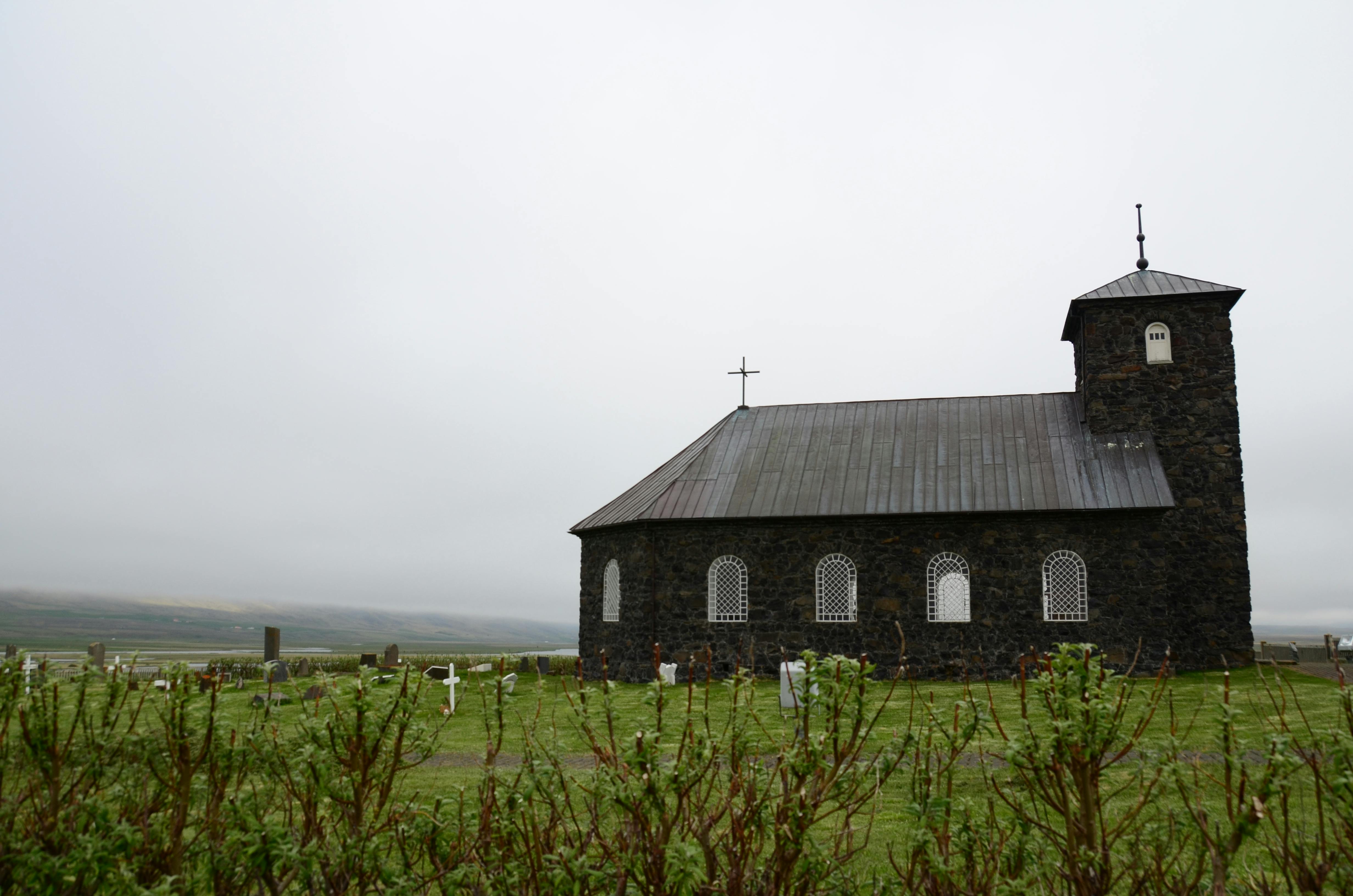 Cobblestone Church on Green Grass Field Under White Sky · Free Stock Photo