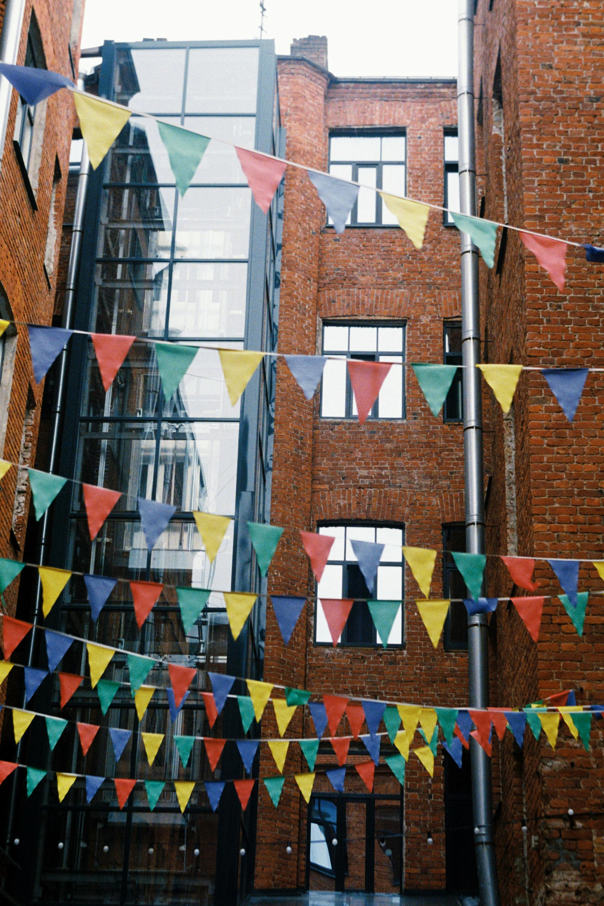 Colorful Triangle Decorations Above the Street Between the Buildings ...