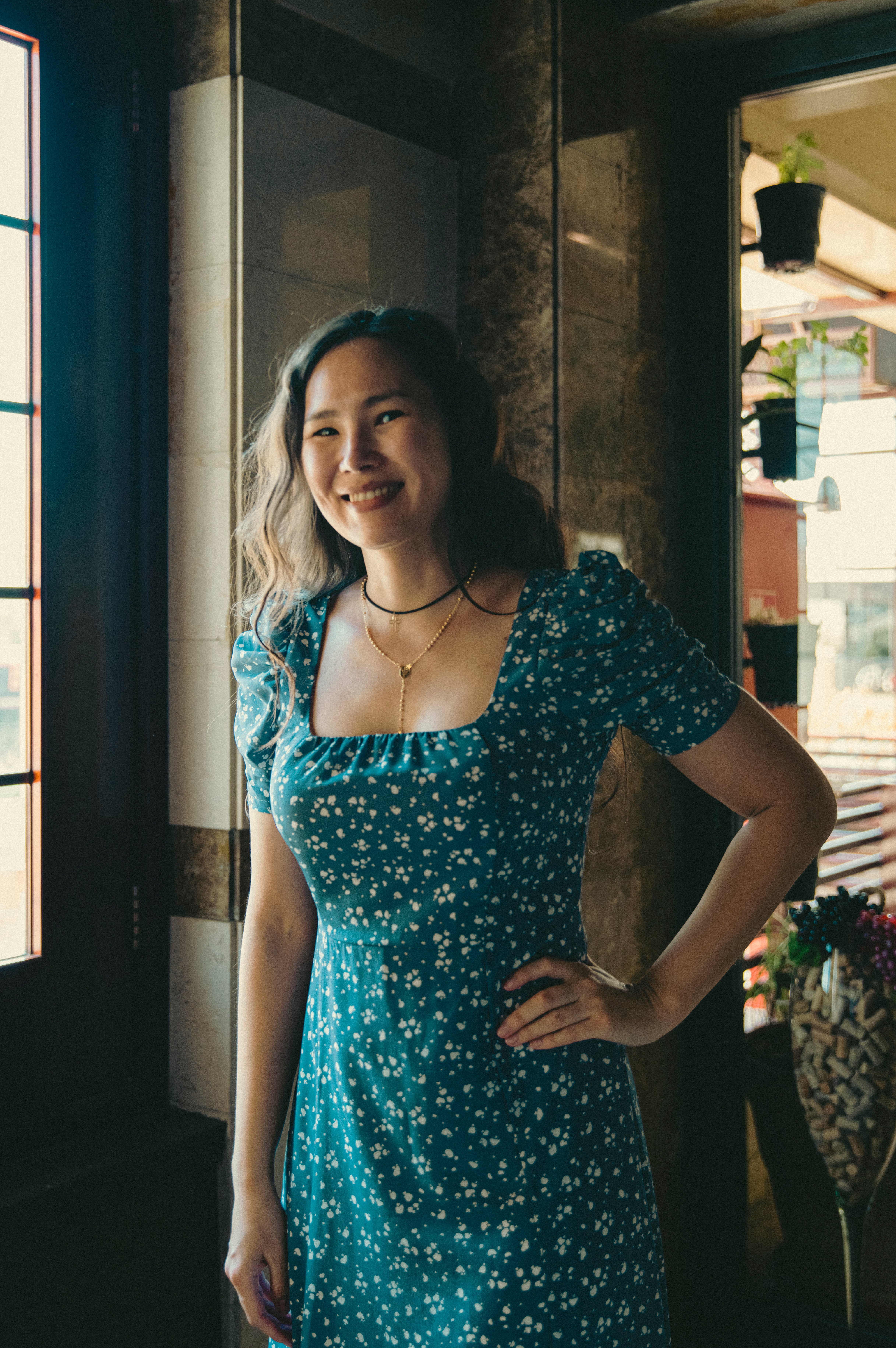 Woman in Blue Floral Dress Smiling at the Camera · Free Stock Photo