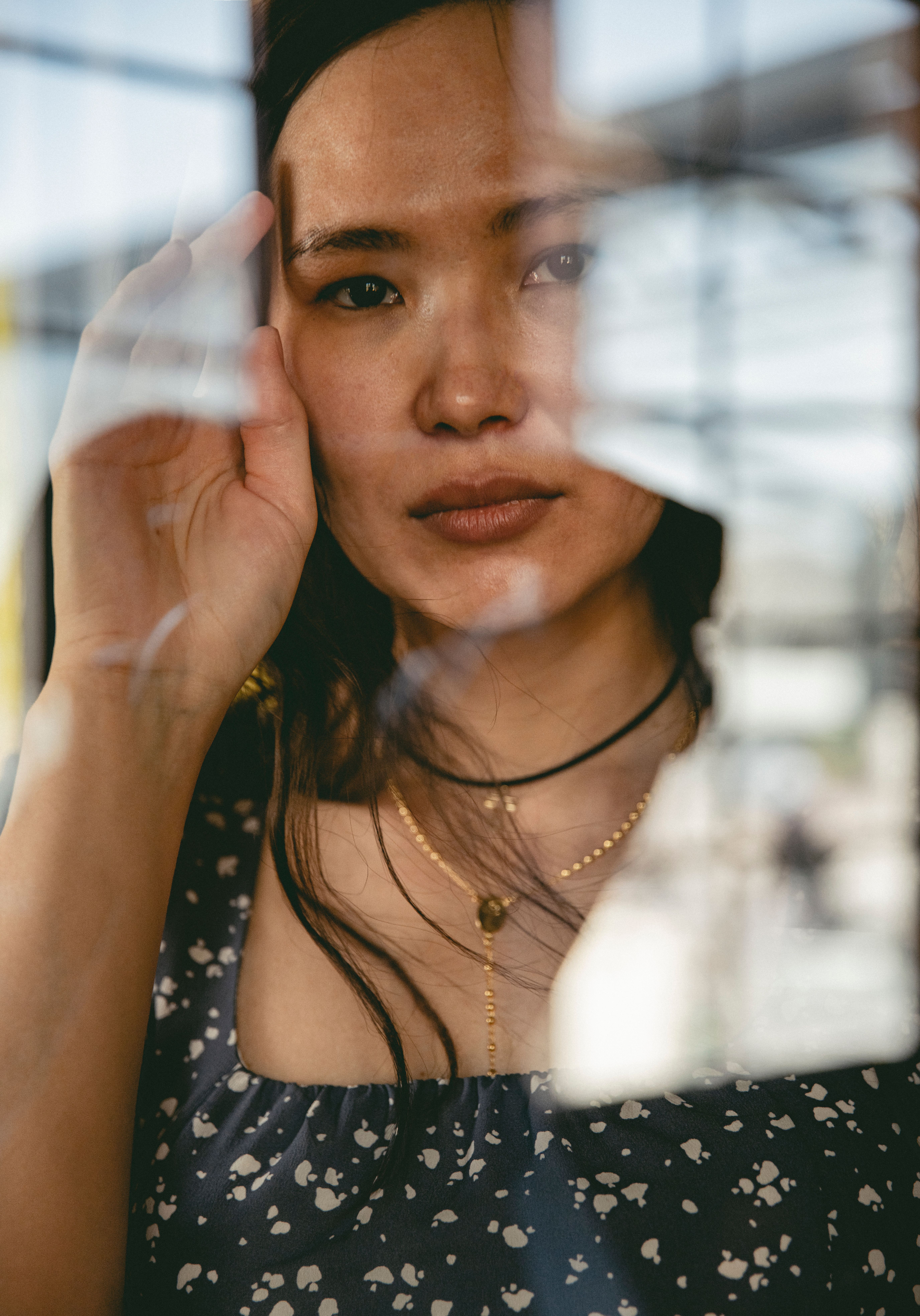 A Woman Standing Behind Glass Window Looking at the Camera · Free Stock ...