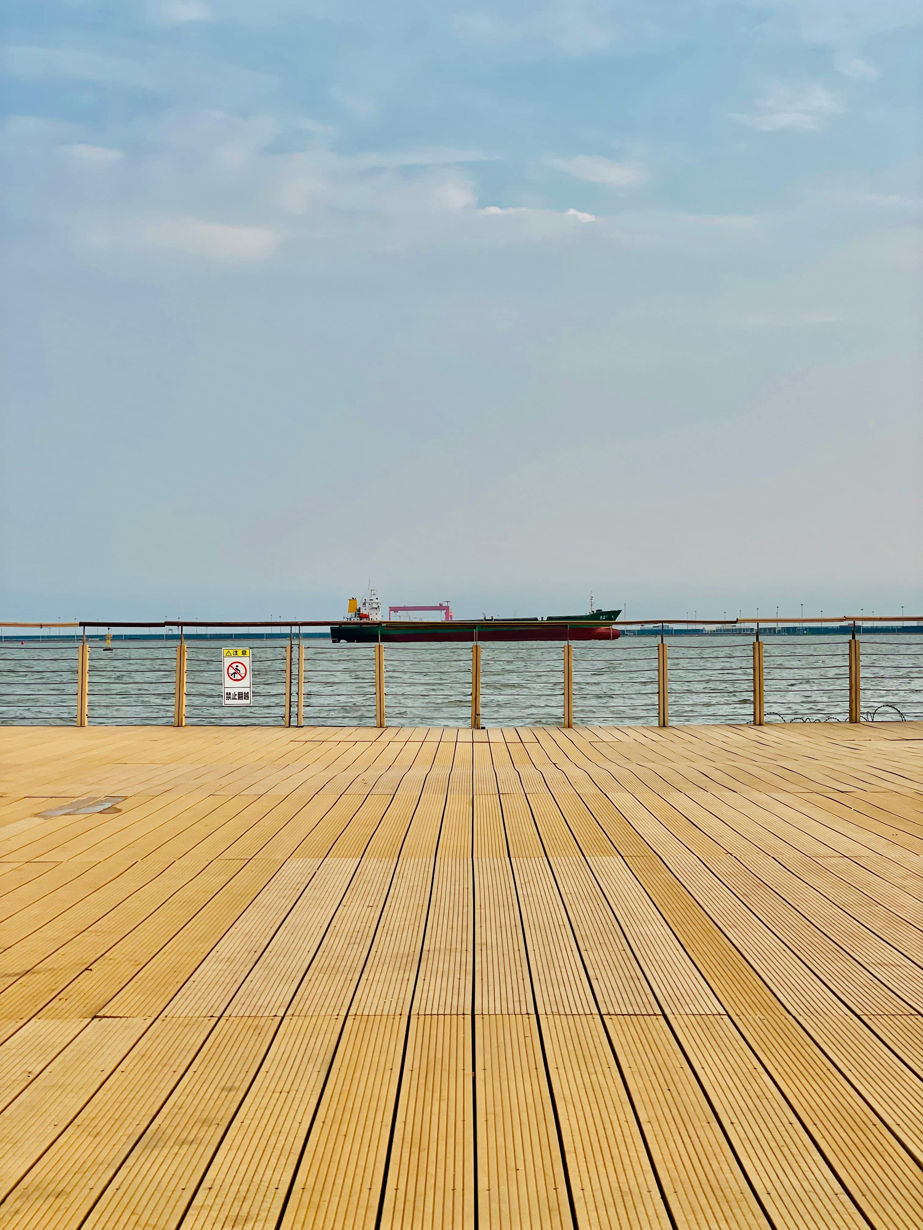 Brown Wooden Dock Beside Sea Under Blue Sky · Free Stock Photo