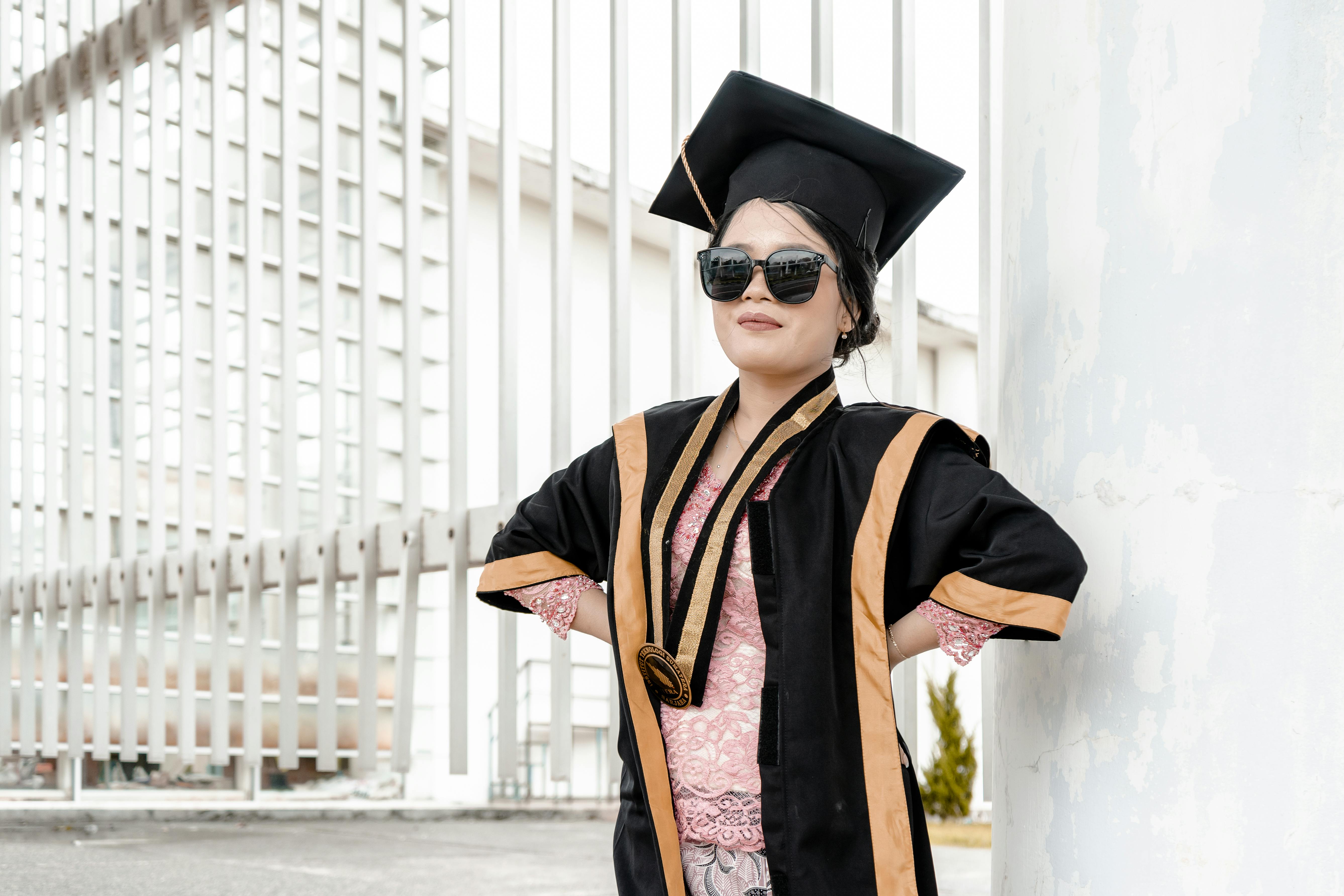 People Wearing Graduation Gowns Tossing their Graduation Caps in the ...
