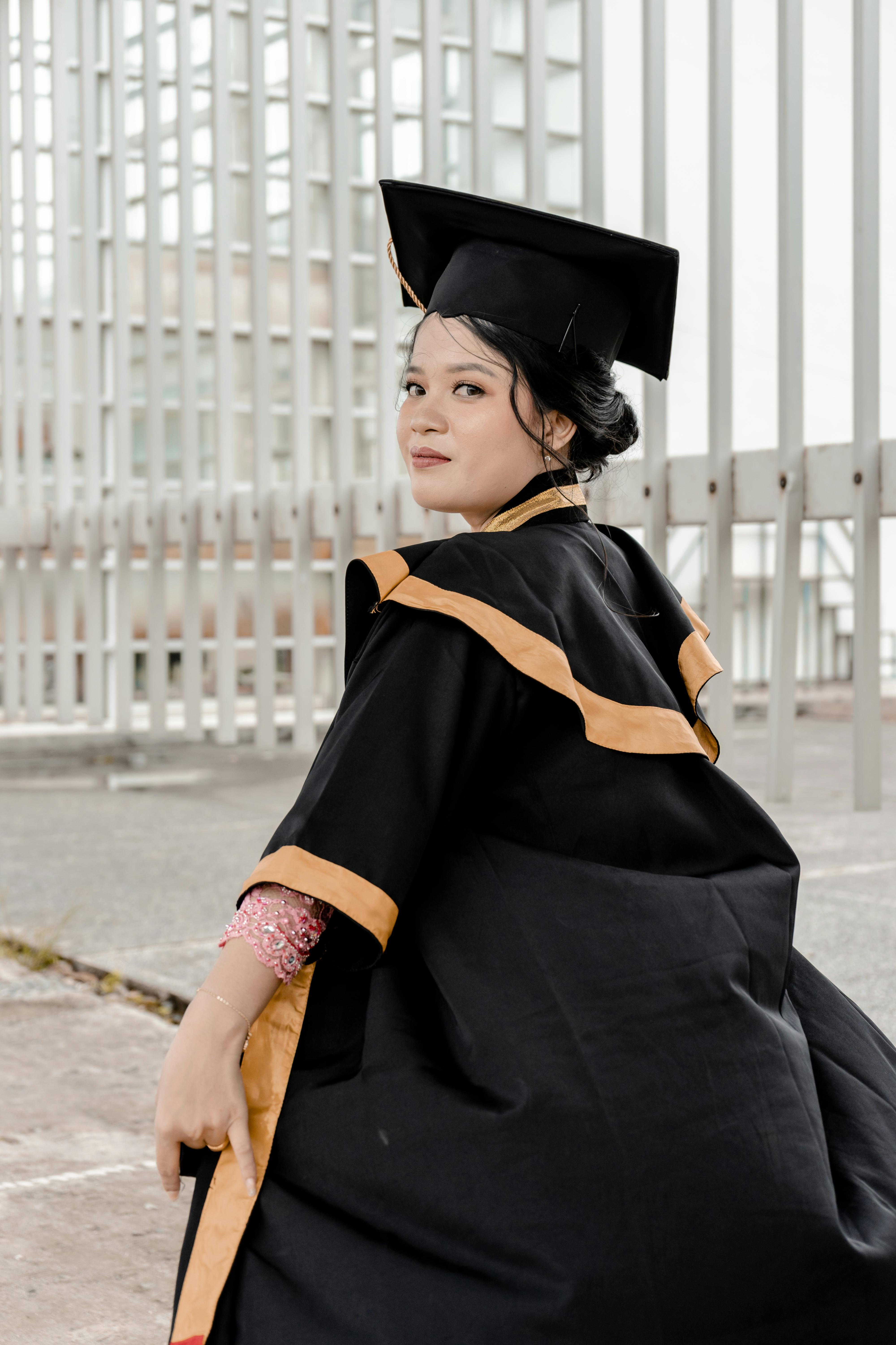 Woman Wearing Academic Dress and Graduation Cap · Free Stock Photo