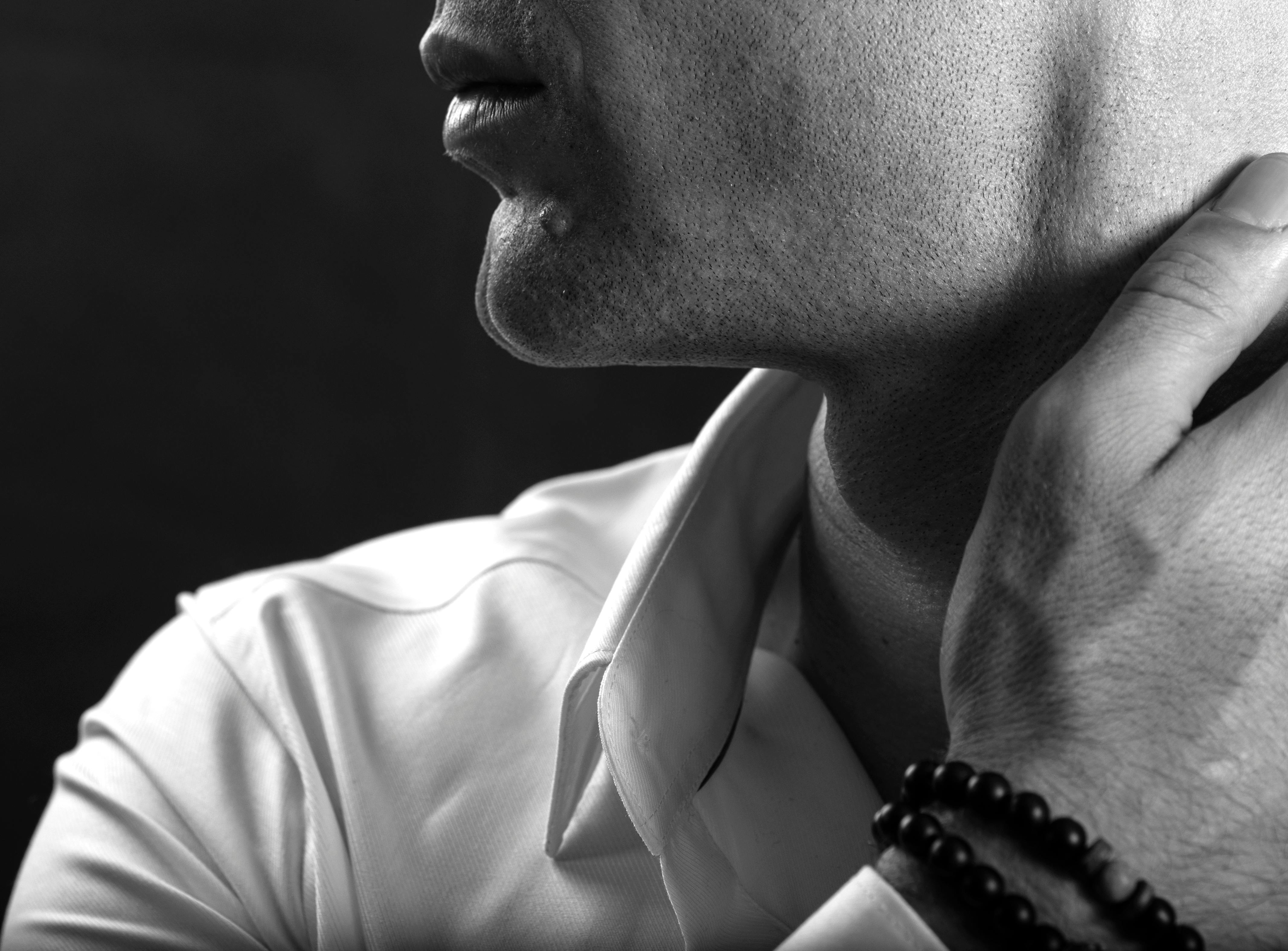 Close-up Shot of a Person Touching His Neck · Free Stock Photo