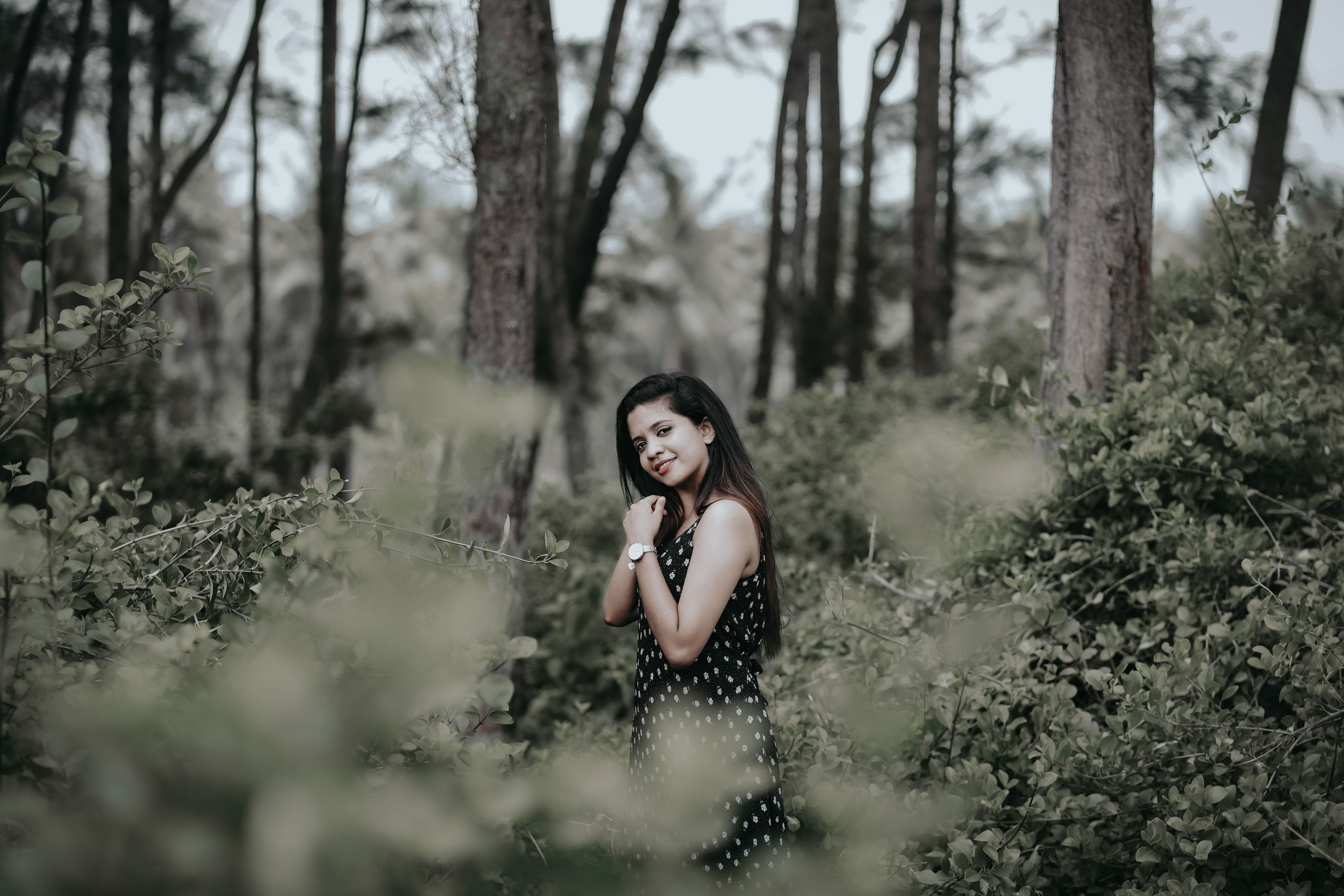 A Woman Standing in the Forest while Smiling at the Camera · Free Stock ...