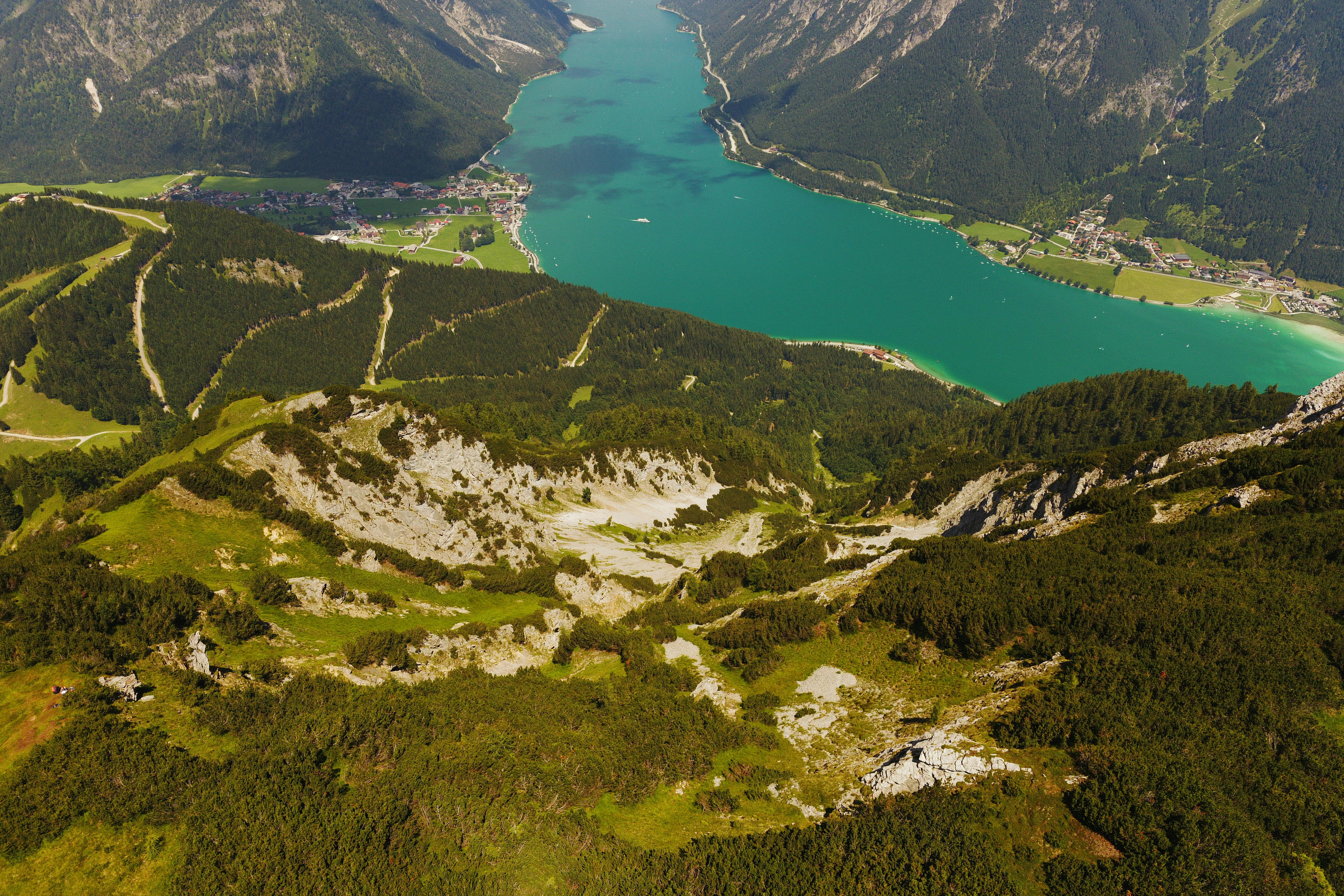 An Aerial Photography of a Lake Between Green Grass Field and Mountain ...