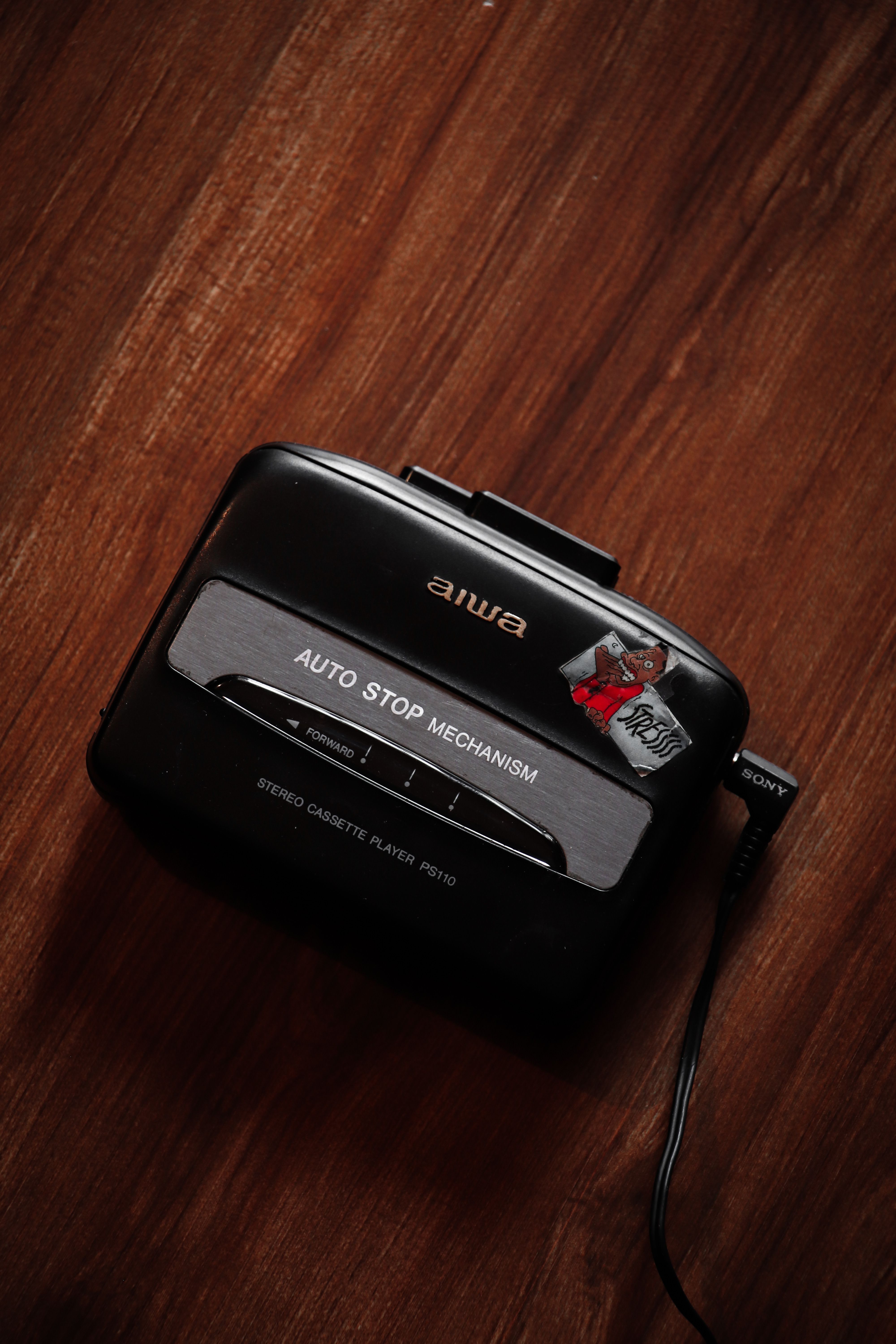 Black Vintage Cassette Player on Wooden Surface · Free Stock Photo
