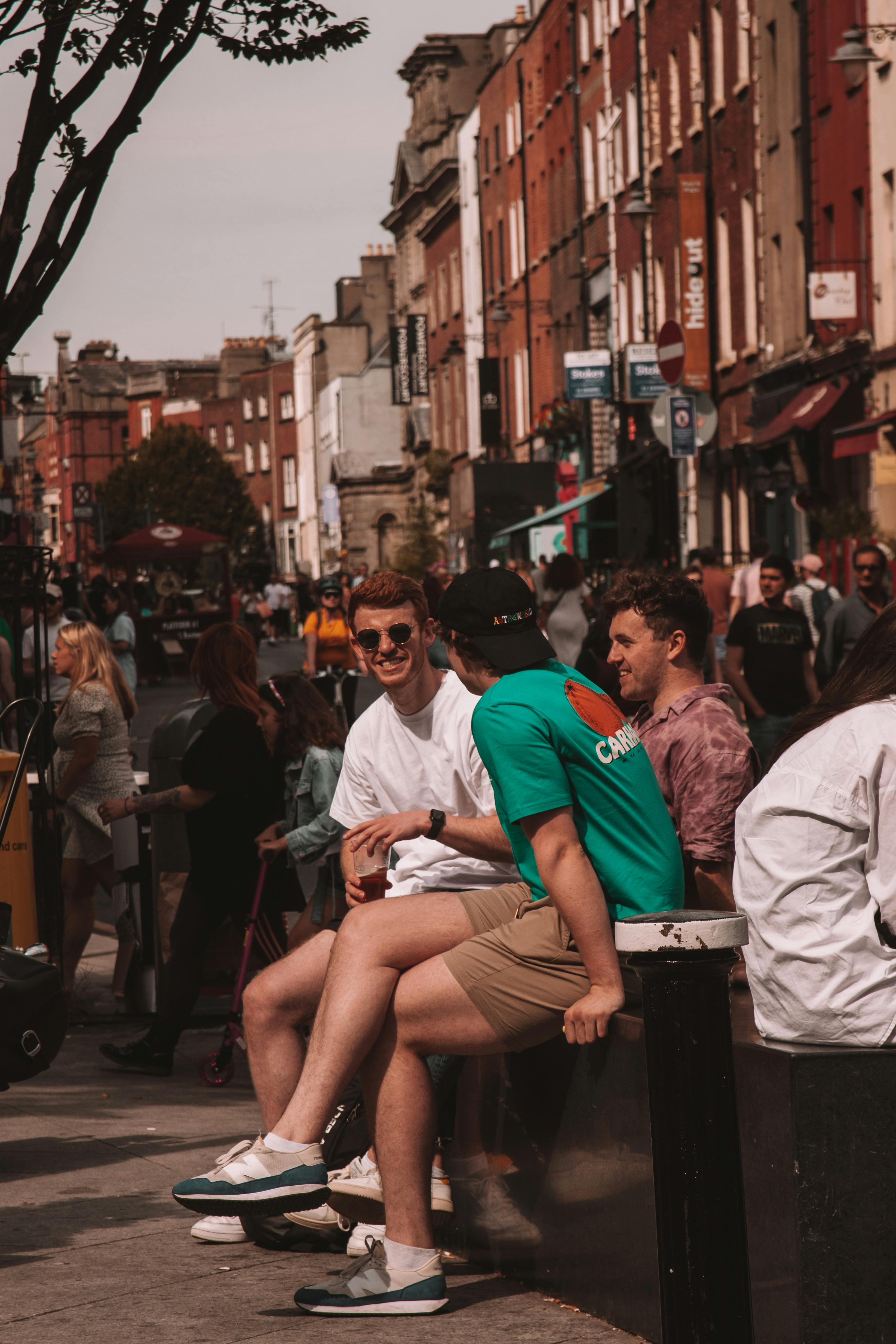 Three Men Talking Together While Arms Crossed · Free Stock Photo
