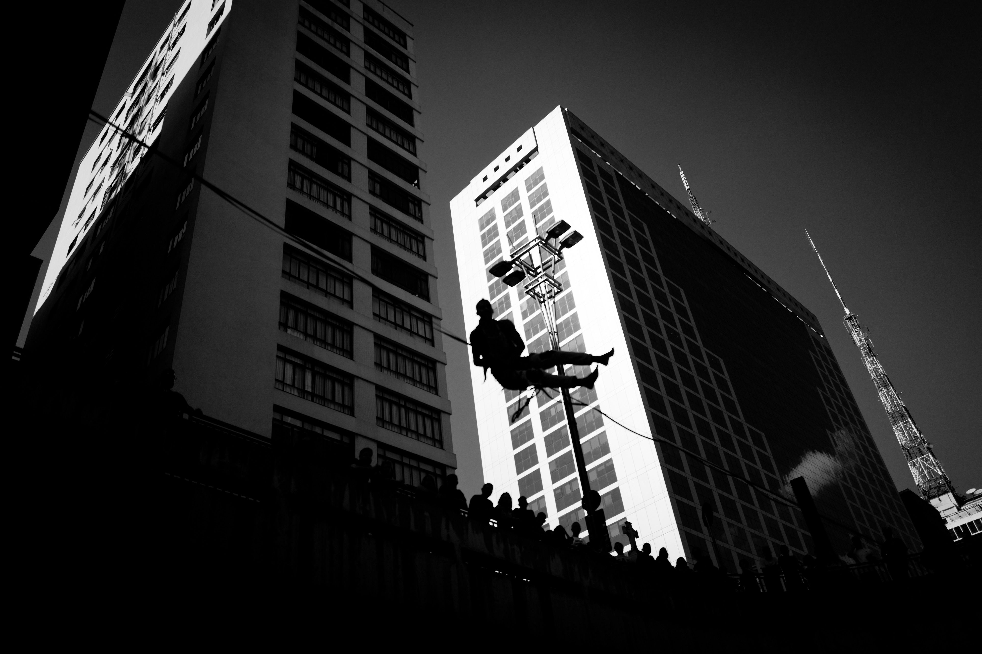 Man Hanging on Rope in Black and White · Free Stock Photo