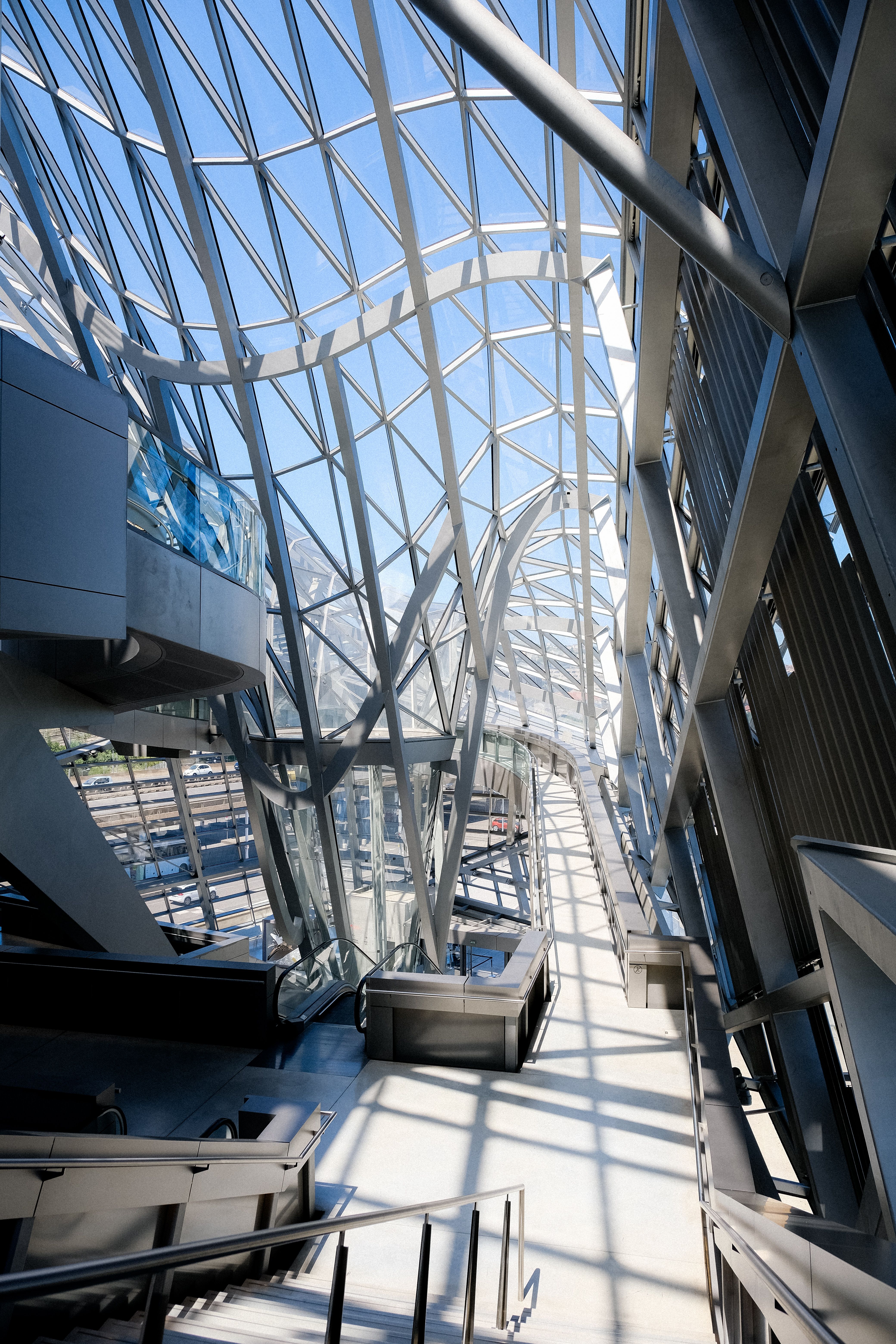 A Glass Roof and Ceiling Building with Metal Frames Under Blue Sky ...