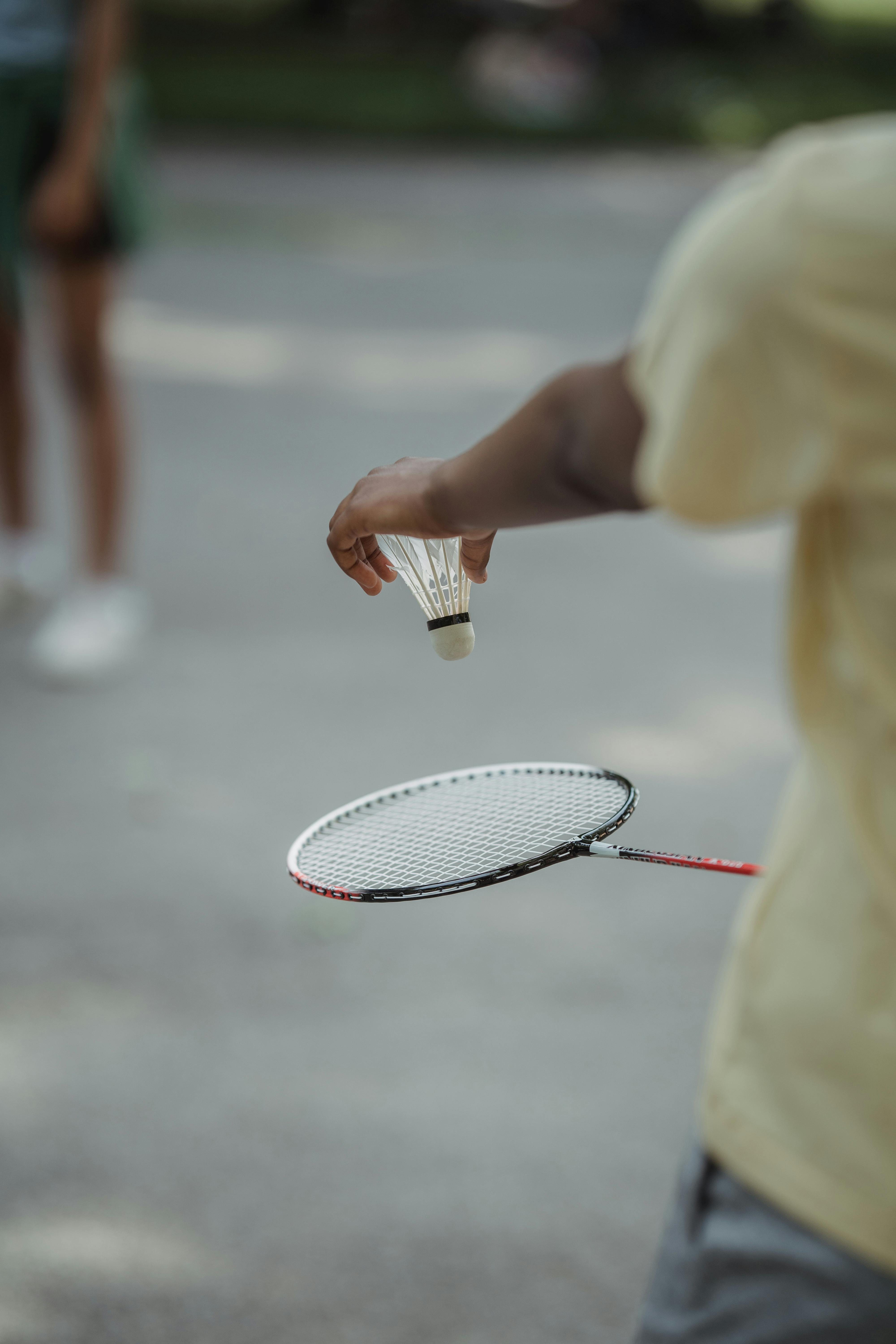 Hands Holding a Badminton Racket and a Shuttlecock · Free Stock Photo