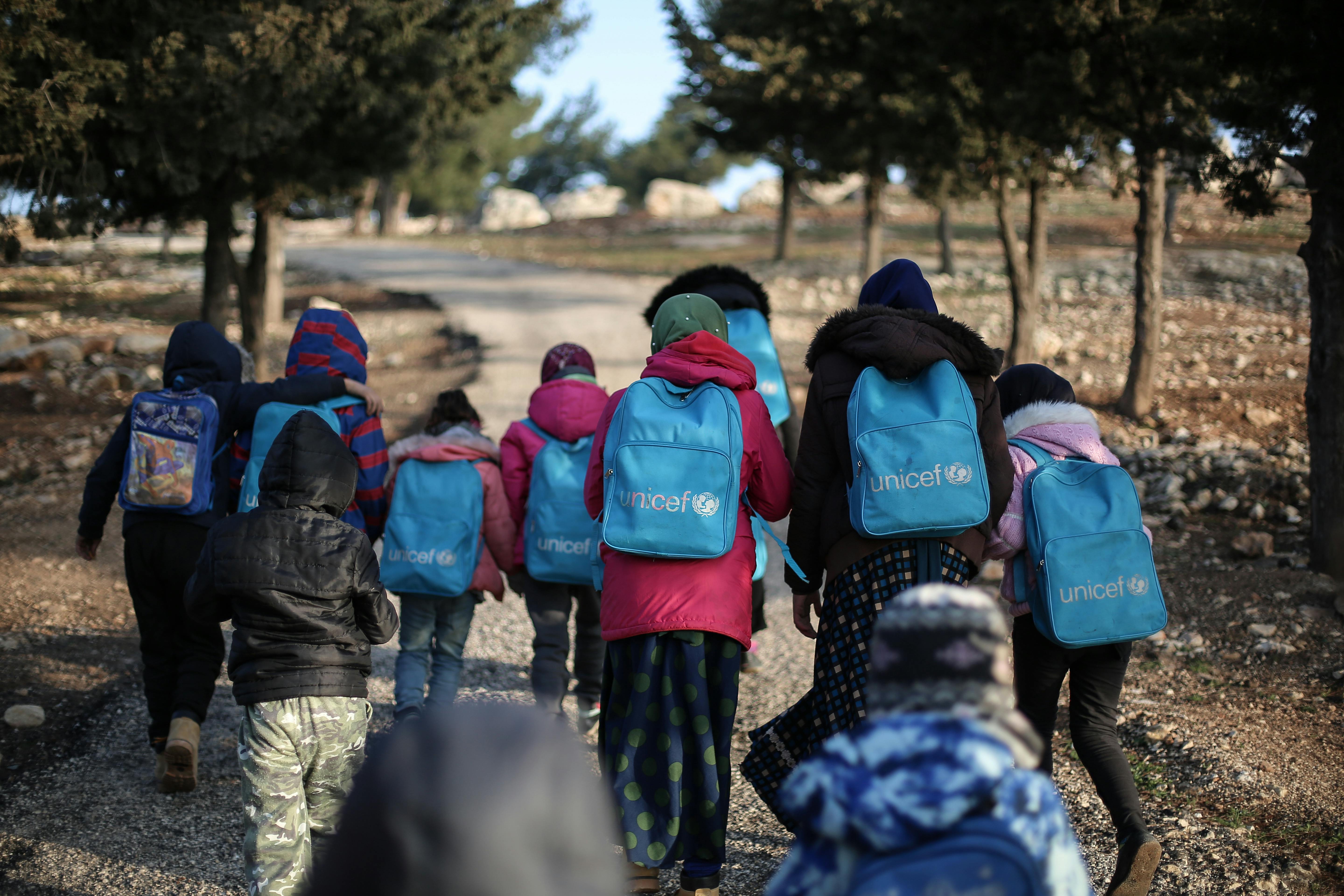 Children Walking with Unicef Backpacks · Free Stock Photo