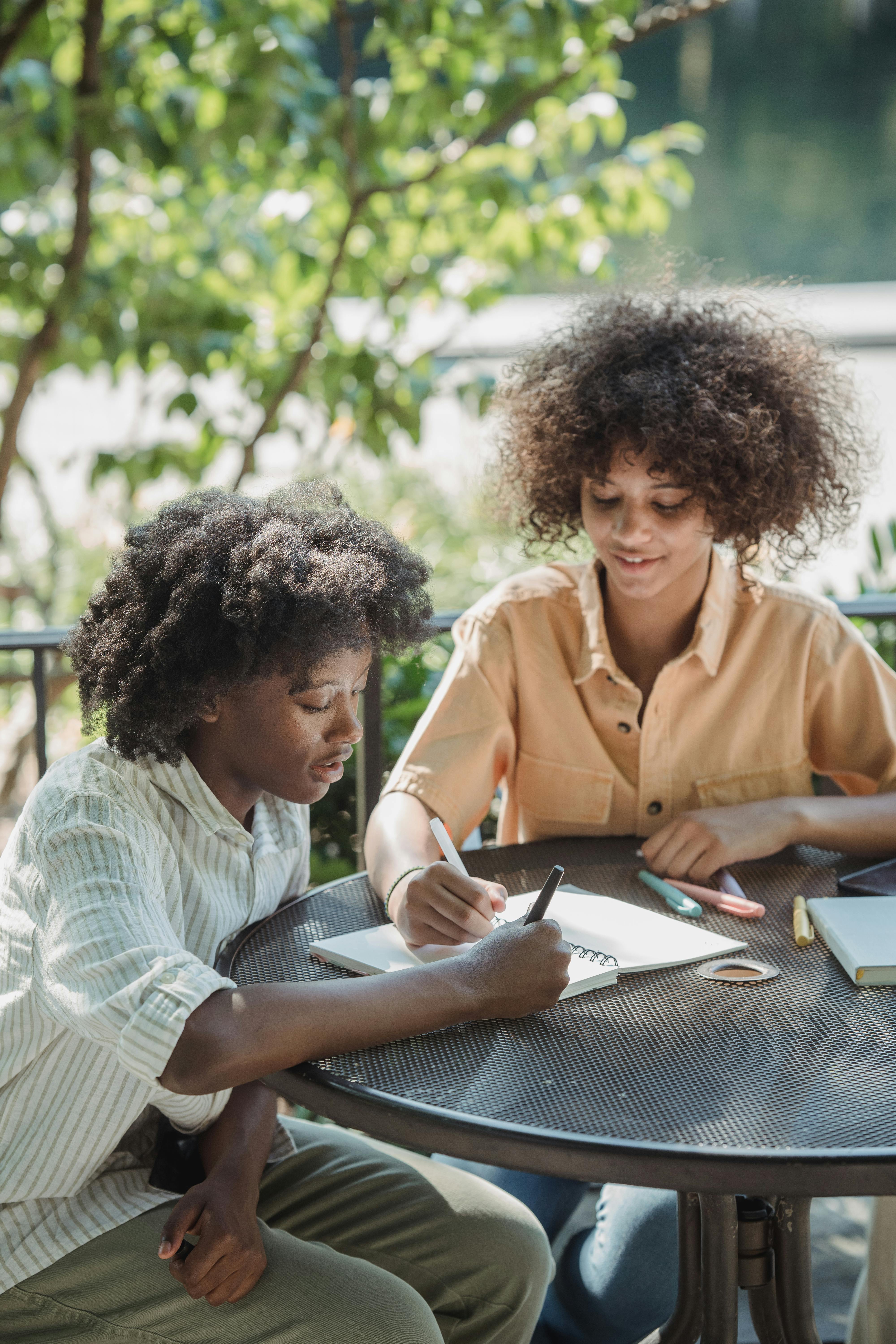 Two Girls Studying at a Table · Free Stock Photo